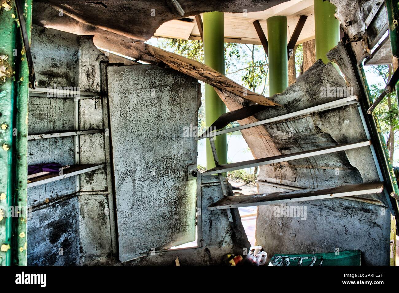 This unique photo shows a green and white small shop destroyed and run ...