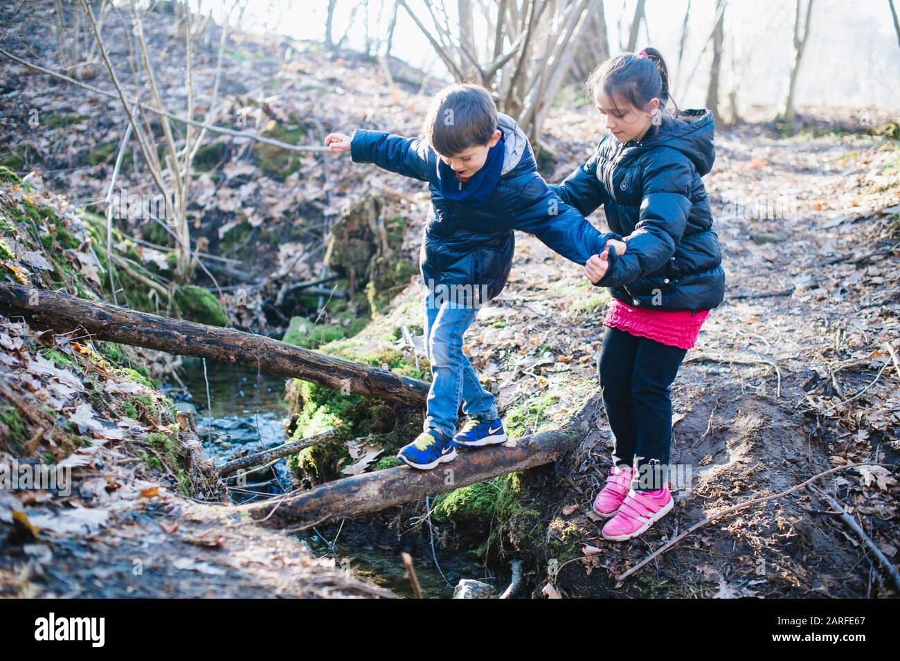 Child crossing a stream hi-res stock photography and images - Alamy