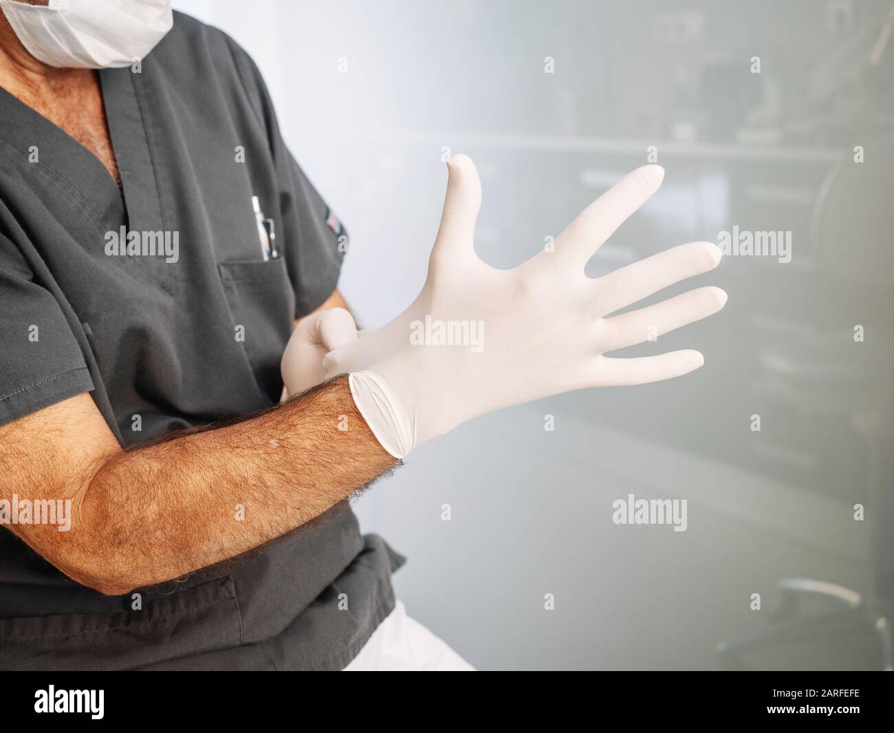 Doctor puts on latex gloves before proceeding to perform his work Stock ...