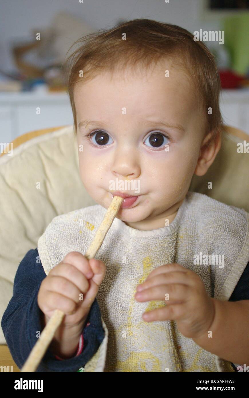 Baby eating bread vertical hi-res stock photography and images - Alamy