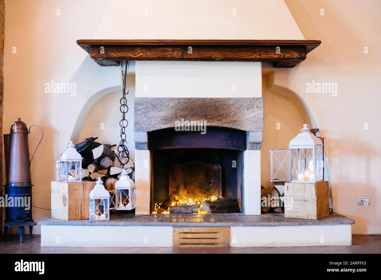 Fireplace decorated with lights and lamps Stock Photo - Alamy