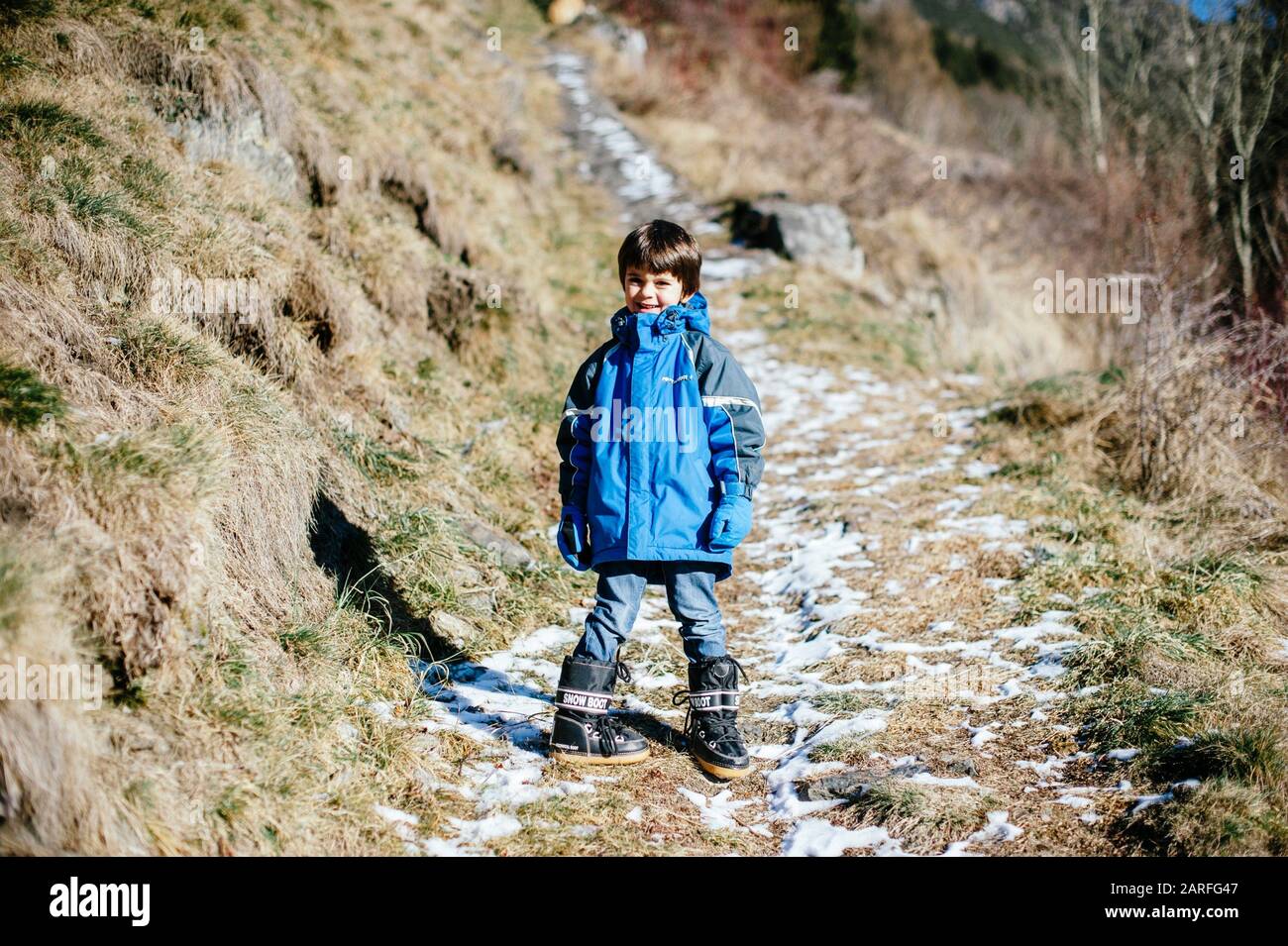 Boy standing on mountain path hi-res stock photography and images - Alamy