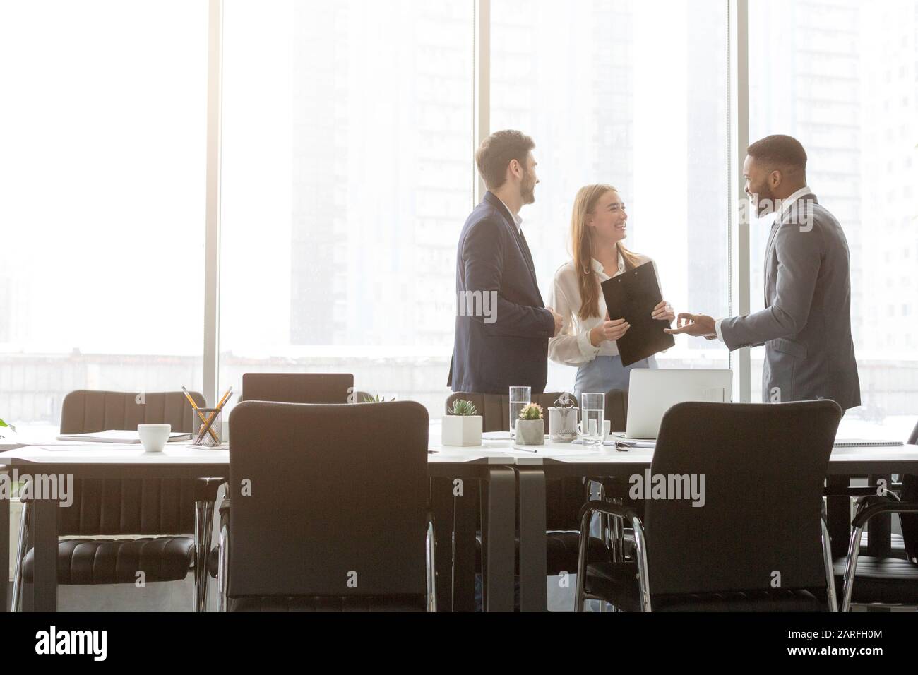 Business colleagues having conversation during break in office Stock ...