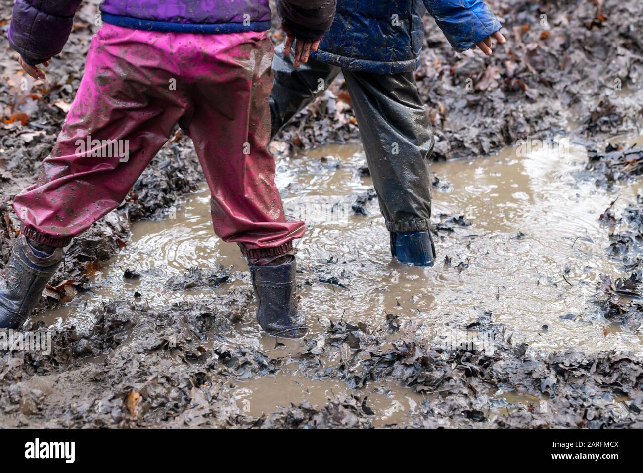 Kid in muddy puddle hi-res stock photography and images - Alamy