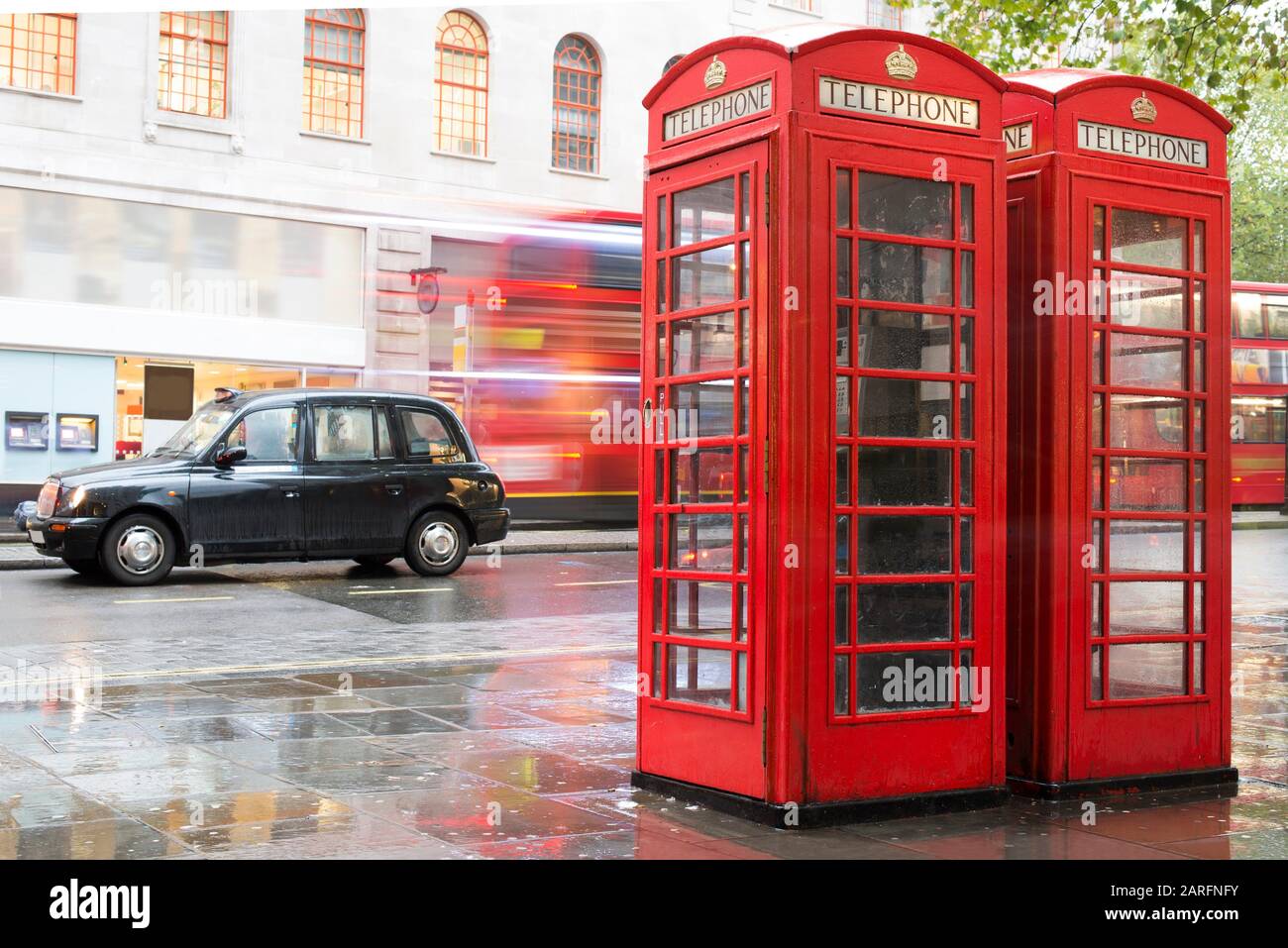 Red Phone cabines in London and vintage taxi. Rainy day. Vintage phone ...