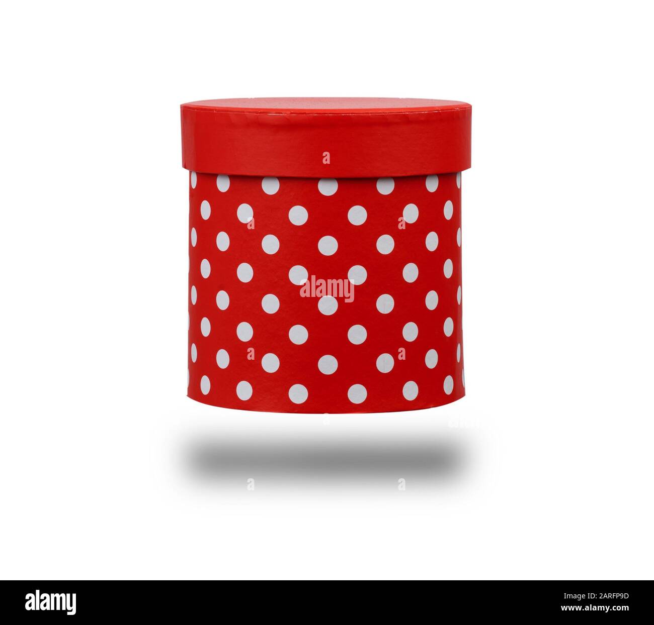 red cardboard box with white polka dots in the shape of a cylinder ...