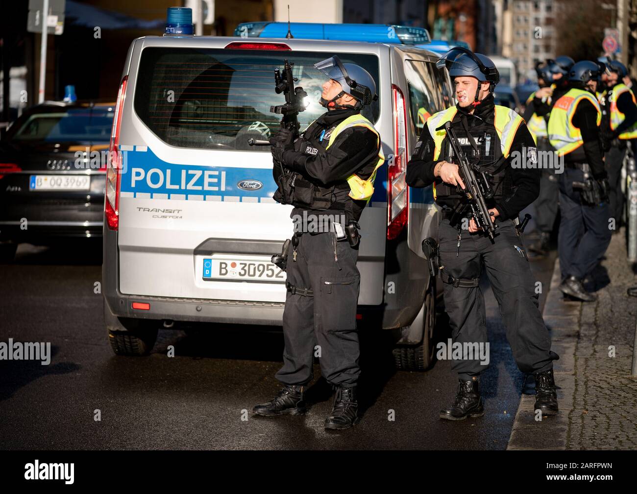 28 January 2020, Berlin: Heavily armed police officers secure the visit ...