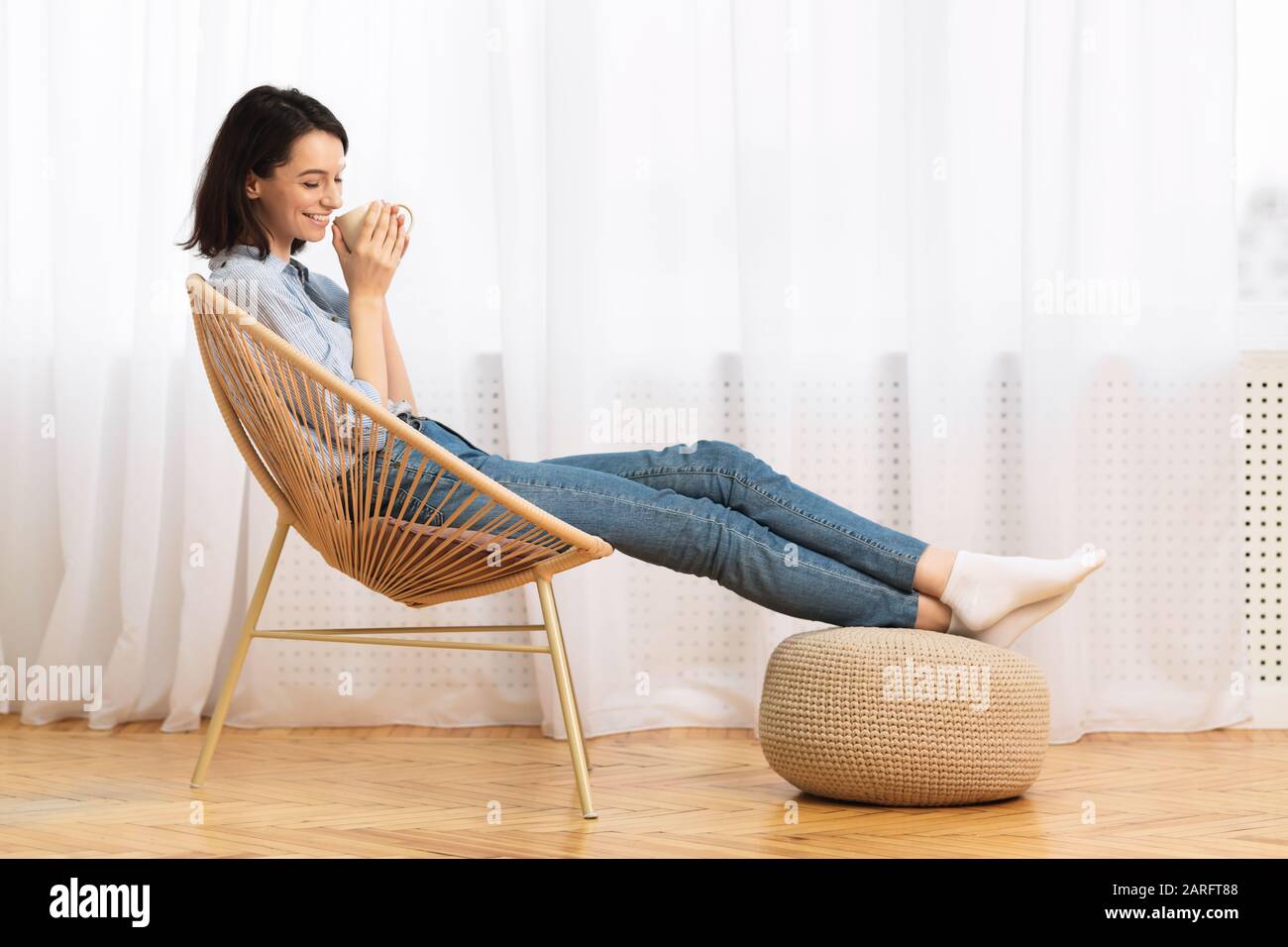 Girl having rest at home with a cup of tea Stock Photo - Alamy