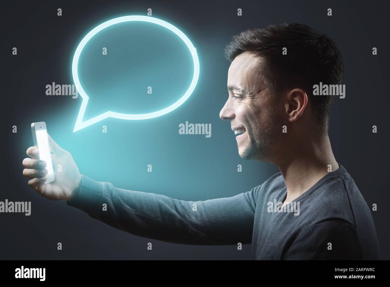 Smiling man getting a message on his smartphone Stock Photo - Alamy