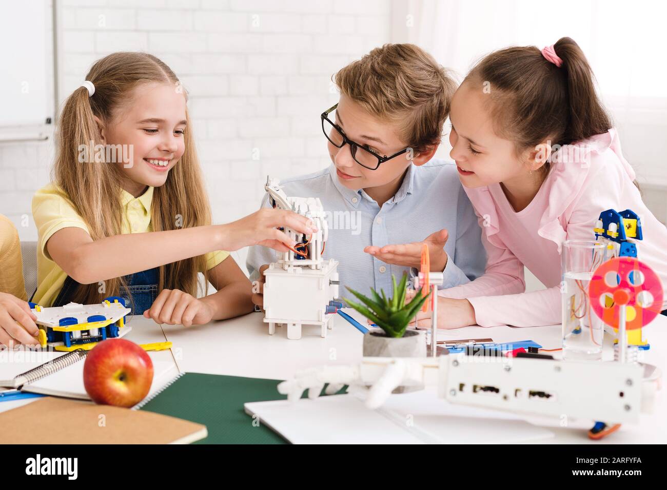 School children creating robot together at lesson Stock Photo - Alamy