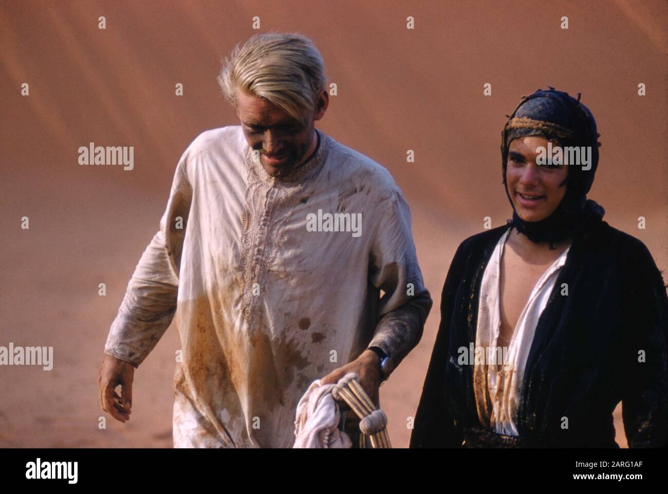 PETER O'TOOLE as T.E. Lawrence and MICHEL RAY as Farraj on set location ...