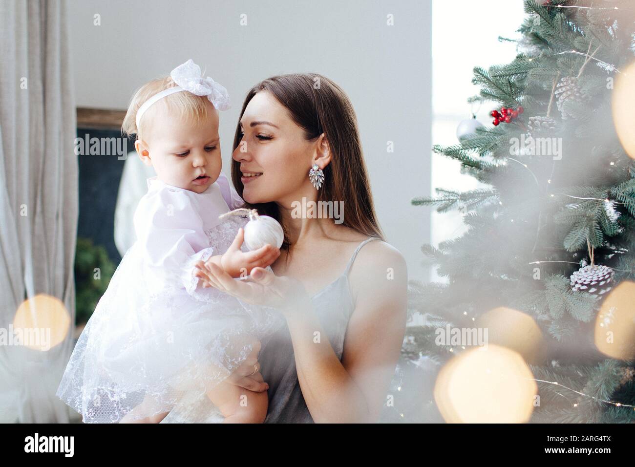 Mom smiles and kisses her daughter. A happy family. Portrait of a ...