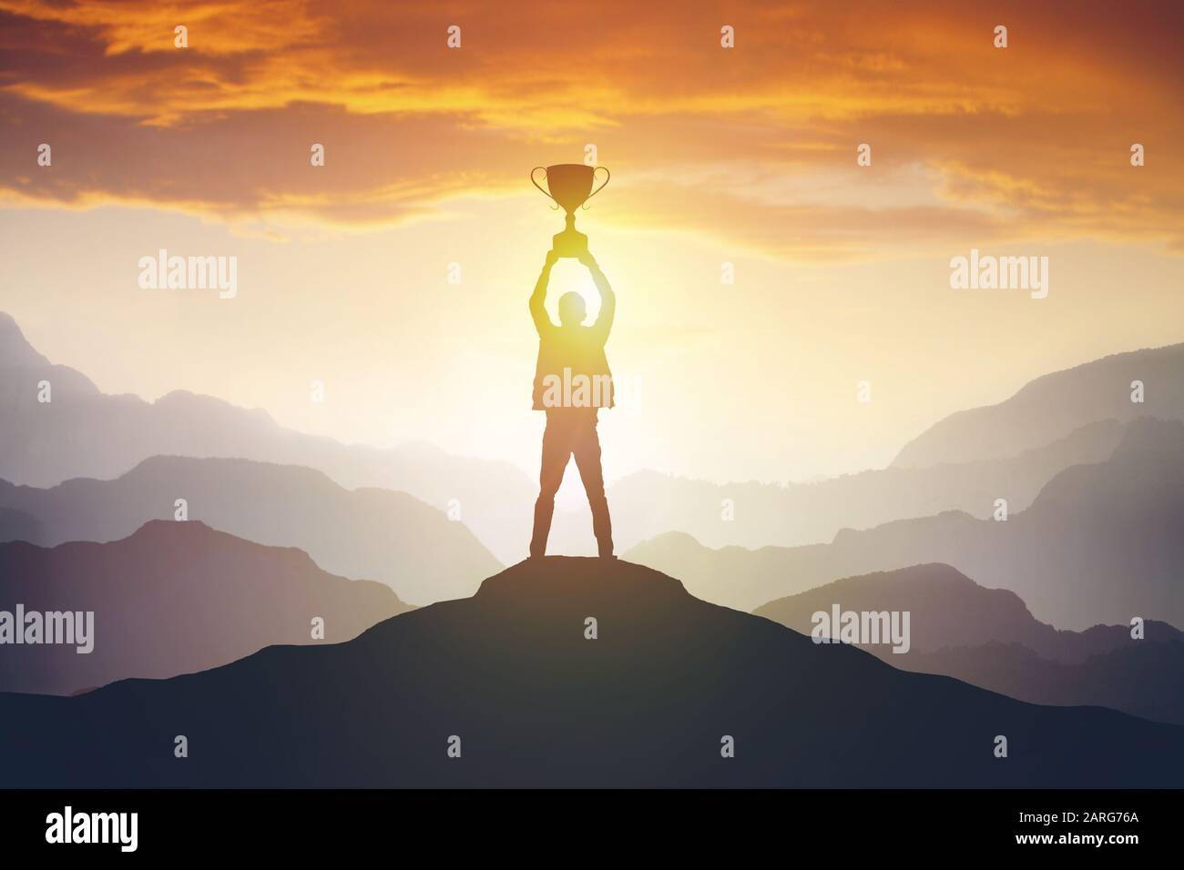 Silhouette of a man holding a trophy at sunset. Success concept Stock ...