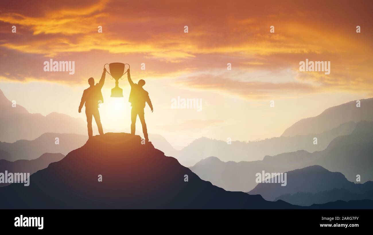 Silhouette of people team with trophy at sunset evening sky background ...