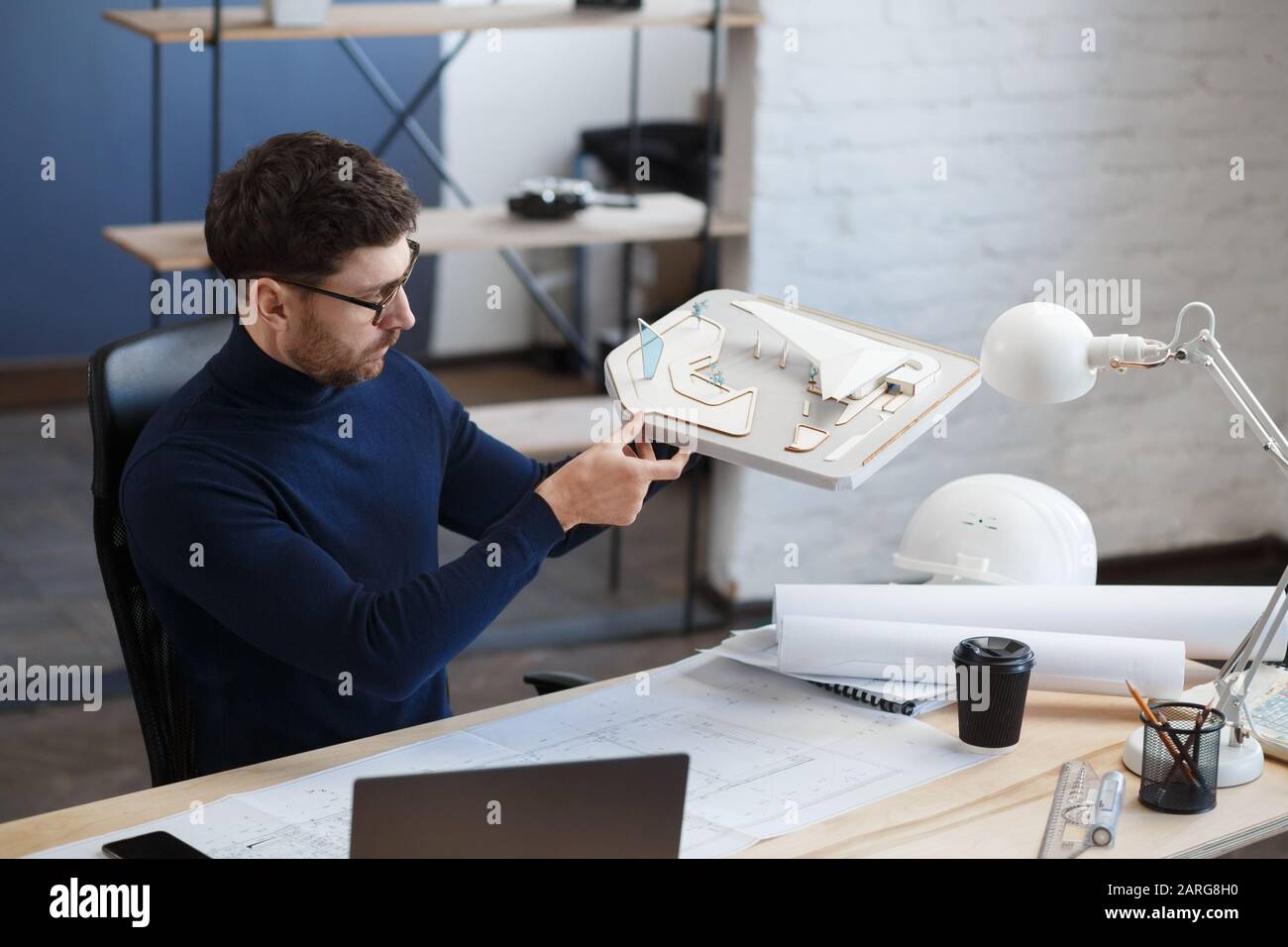 Architect working in office with building 3D model. Engineer inspect ...