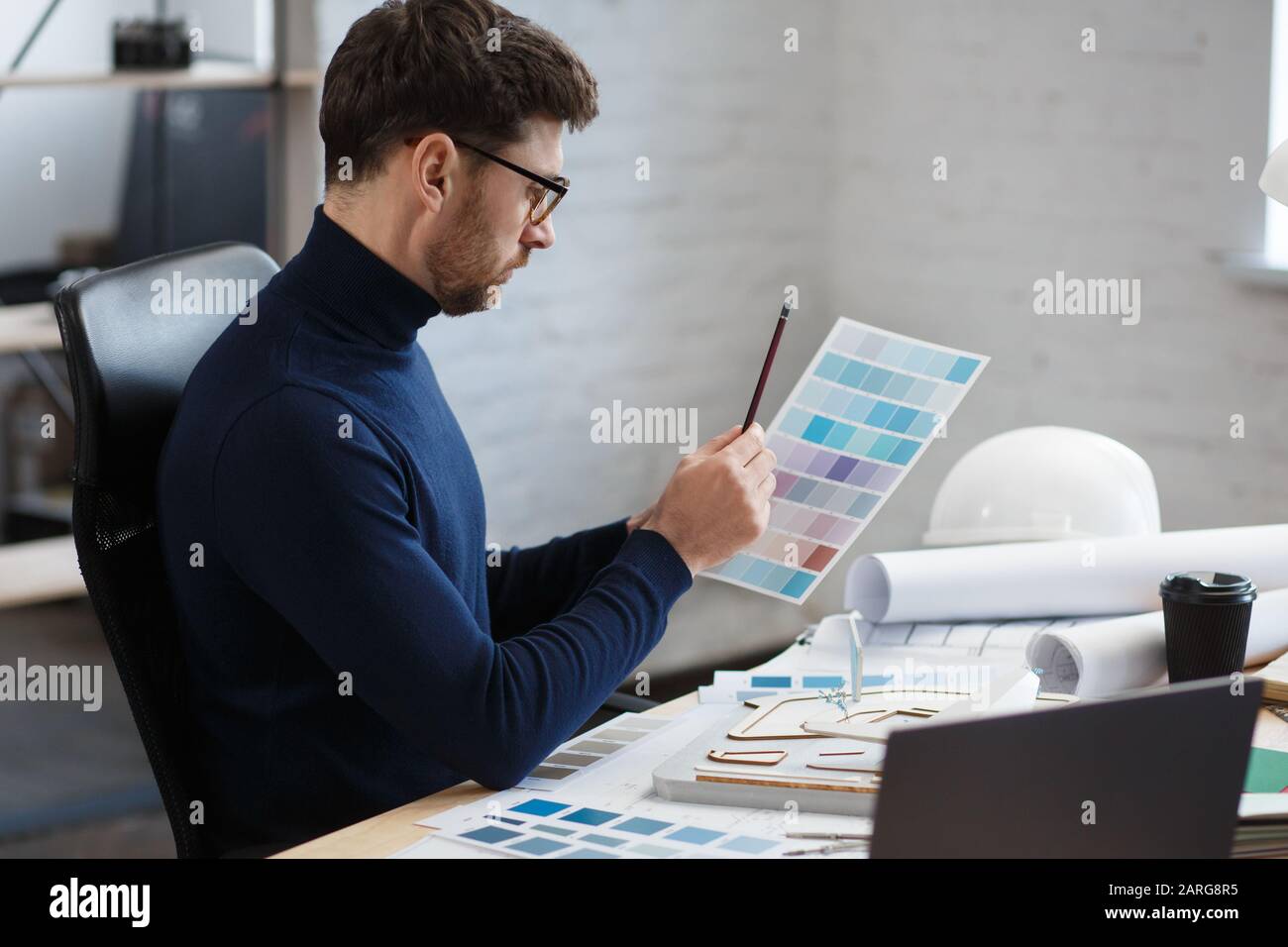 Architect working in office with color palette. Engineer select colors ...