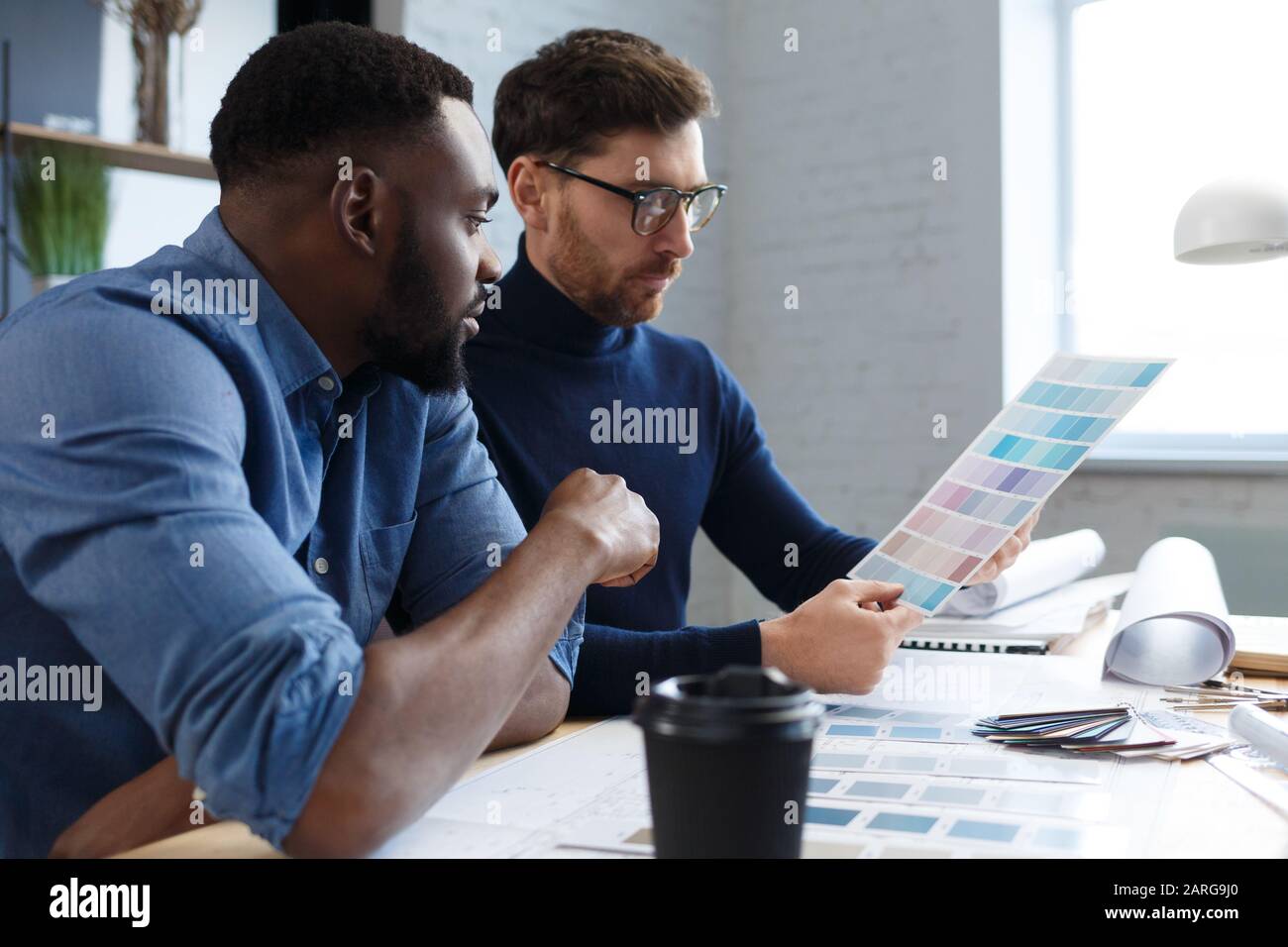 Multiracial engineer team working in office with color palette ...
