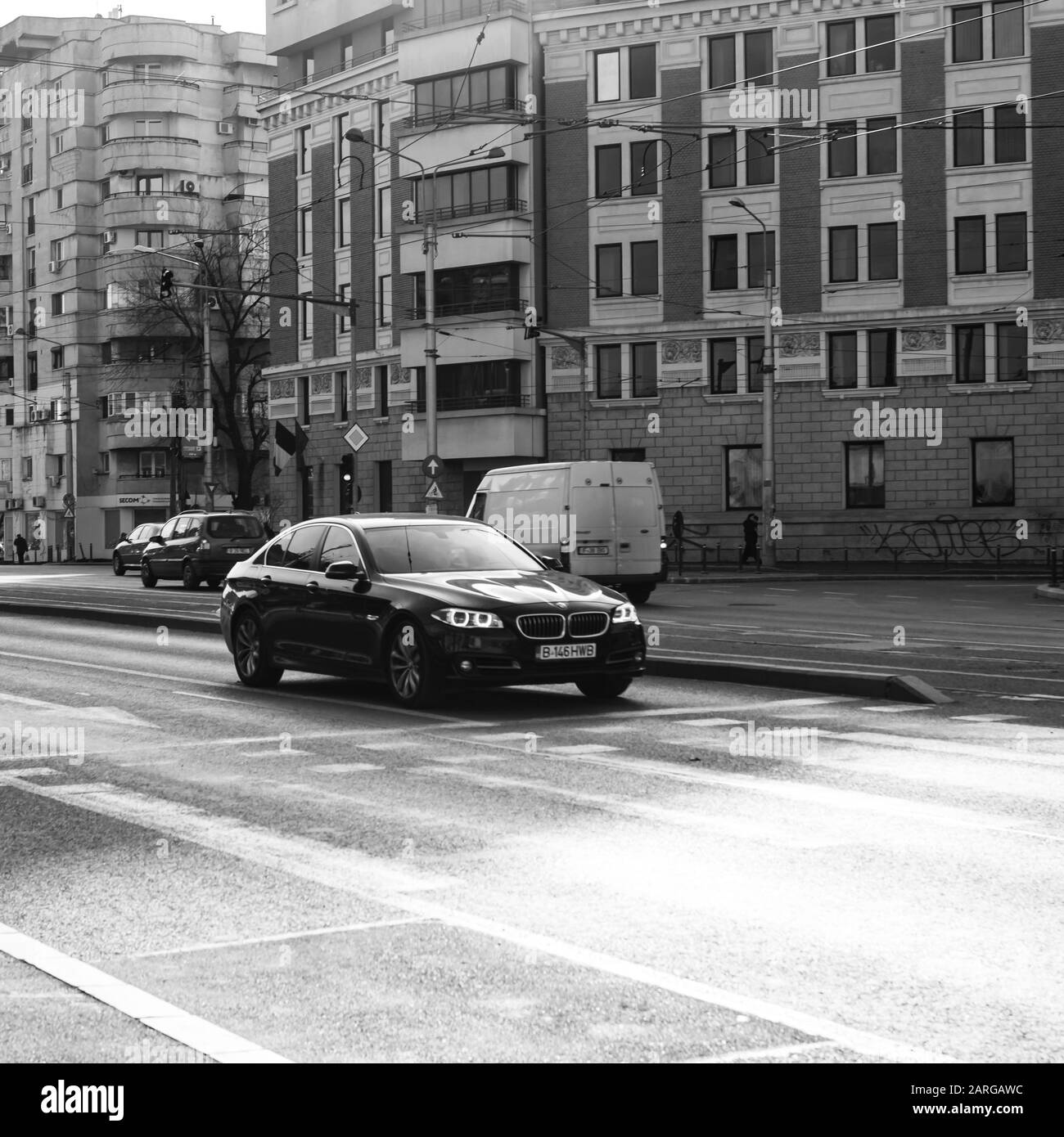 Car traffic at rush hour in downtown area. New BMW car waiting at ...