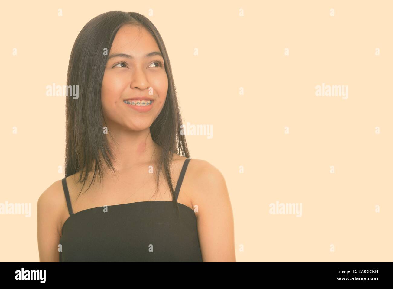 Studio shot of young happy Asian teenage girl smiling Stock Photo - Alamy