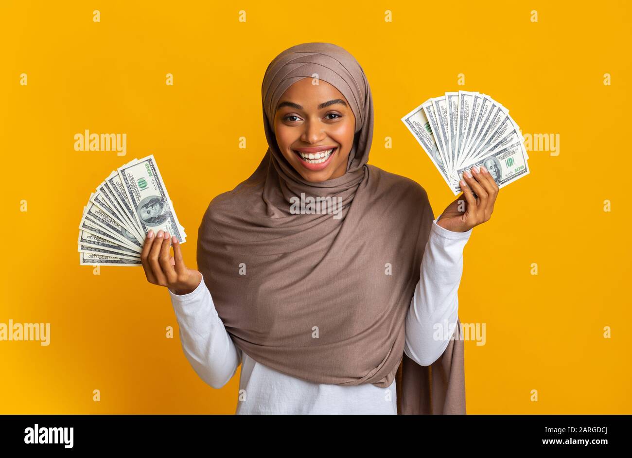 Overjoyed Black Muslim Girl in Hijab Holding Lots Of Dollar Cash Stock ...