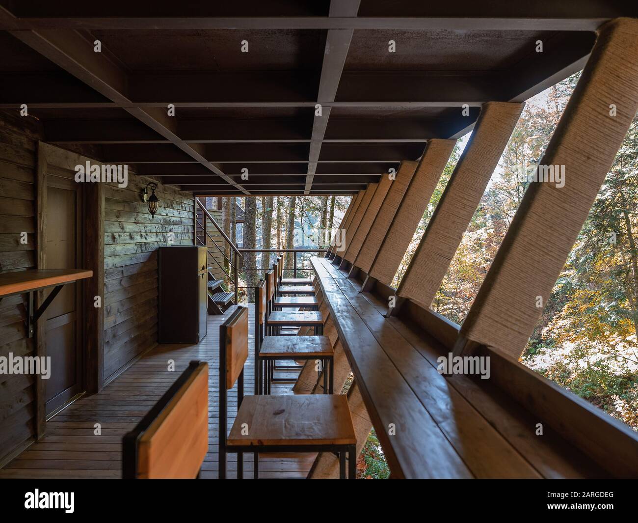 The balcony of forest cafe is made of wood with wooden furniture ...