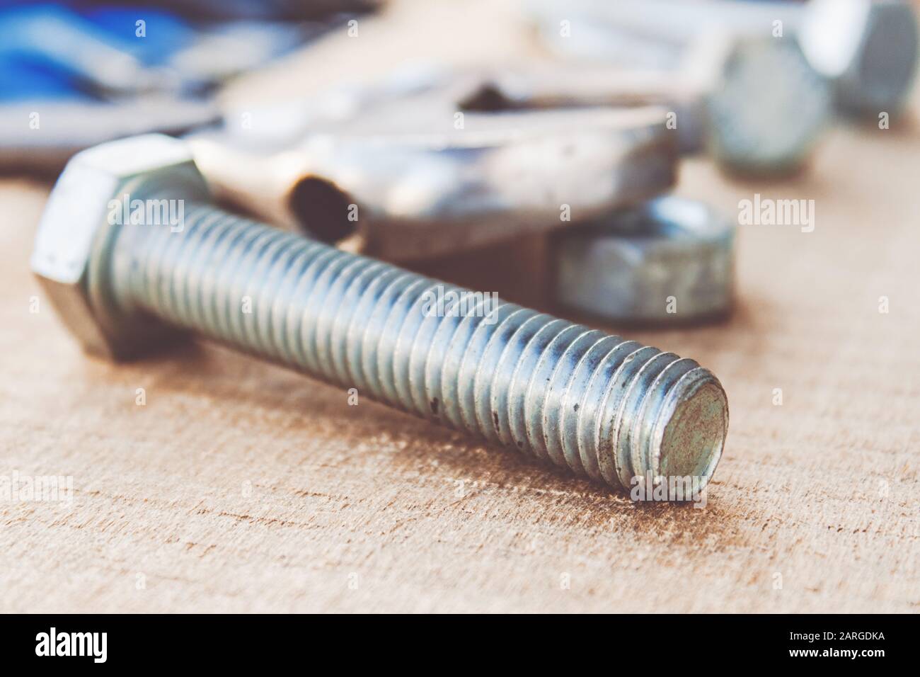 Steel nut bolt and washers lie on wooden boards. The concept of tools ...