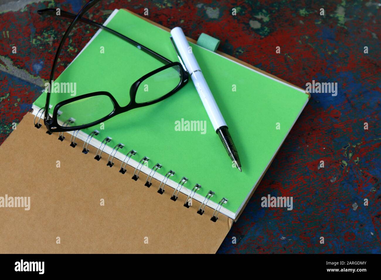 Photo of a notebook, pen and eyeglasses Stock Photo - Alamy