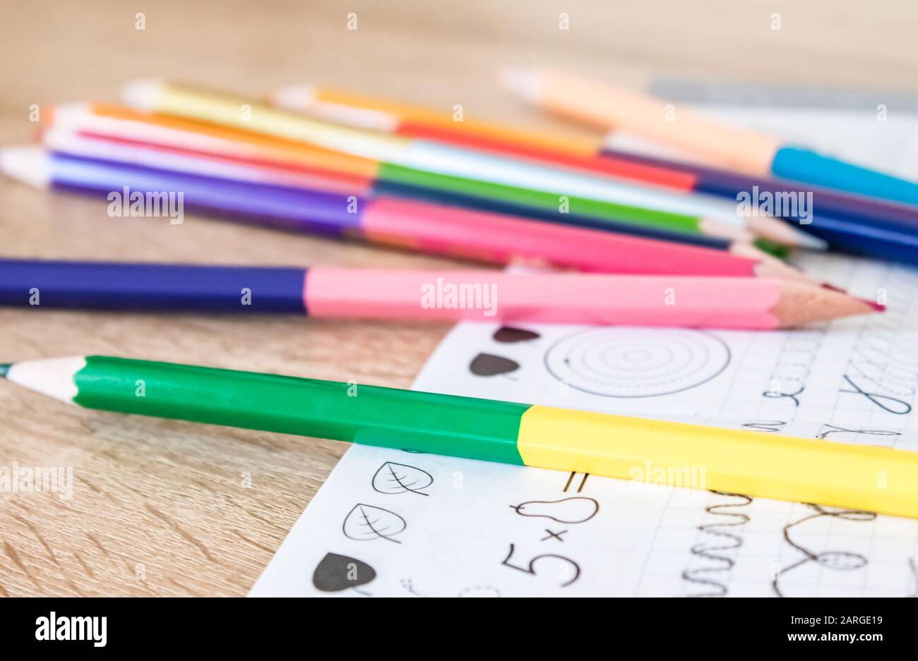 Colored pencils scattered on a school notebook. Close-up Stock Photo ...