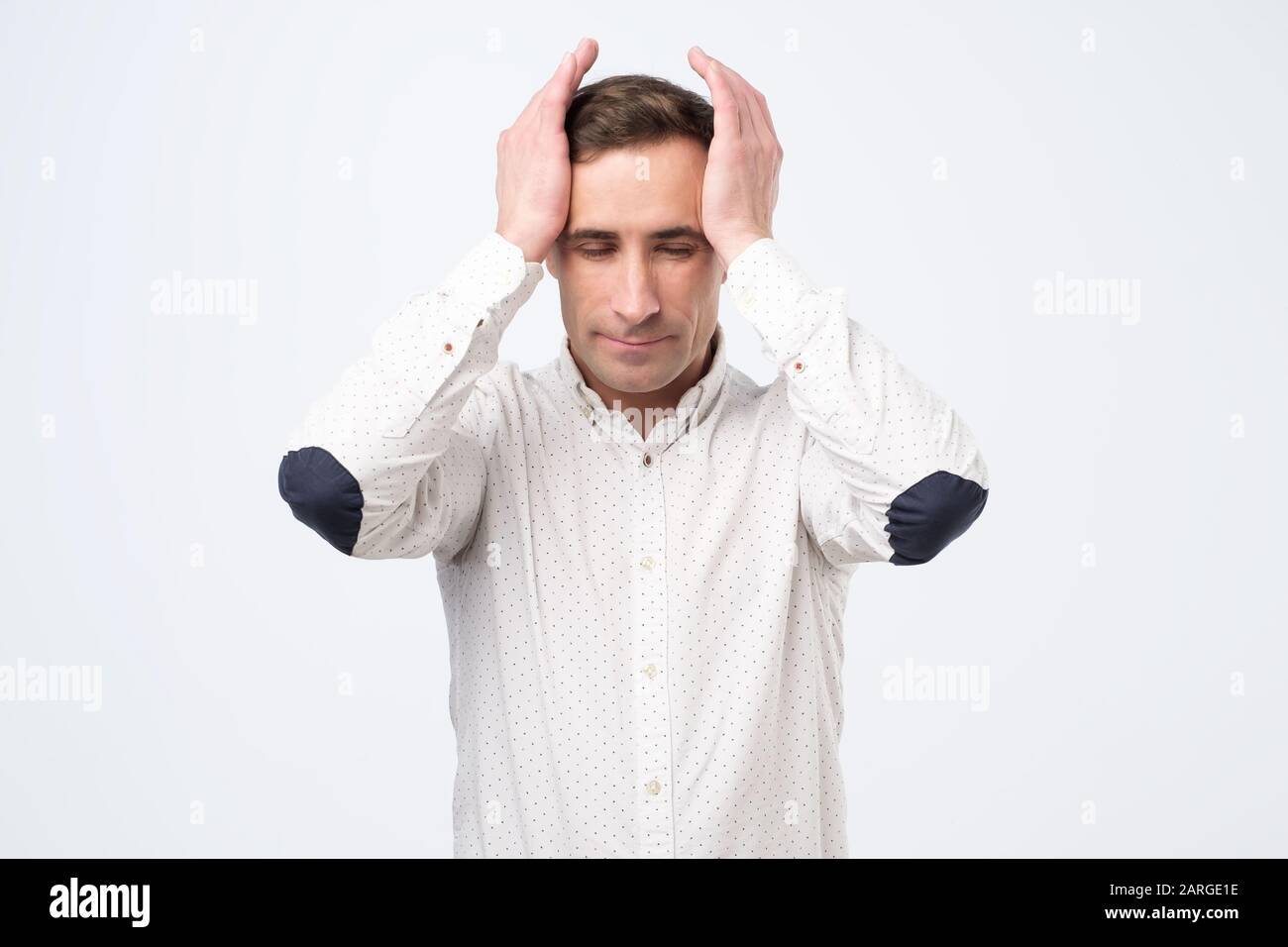 Worried young italian man suffering from headache. Studio shot Stock ...