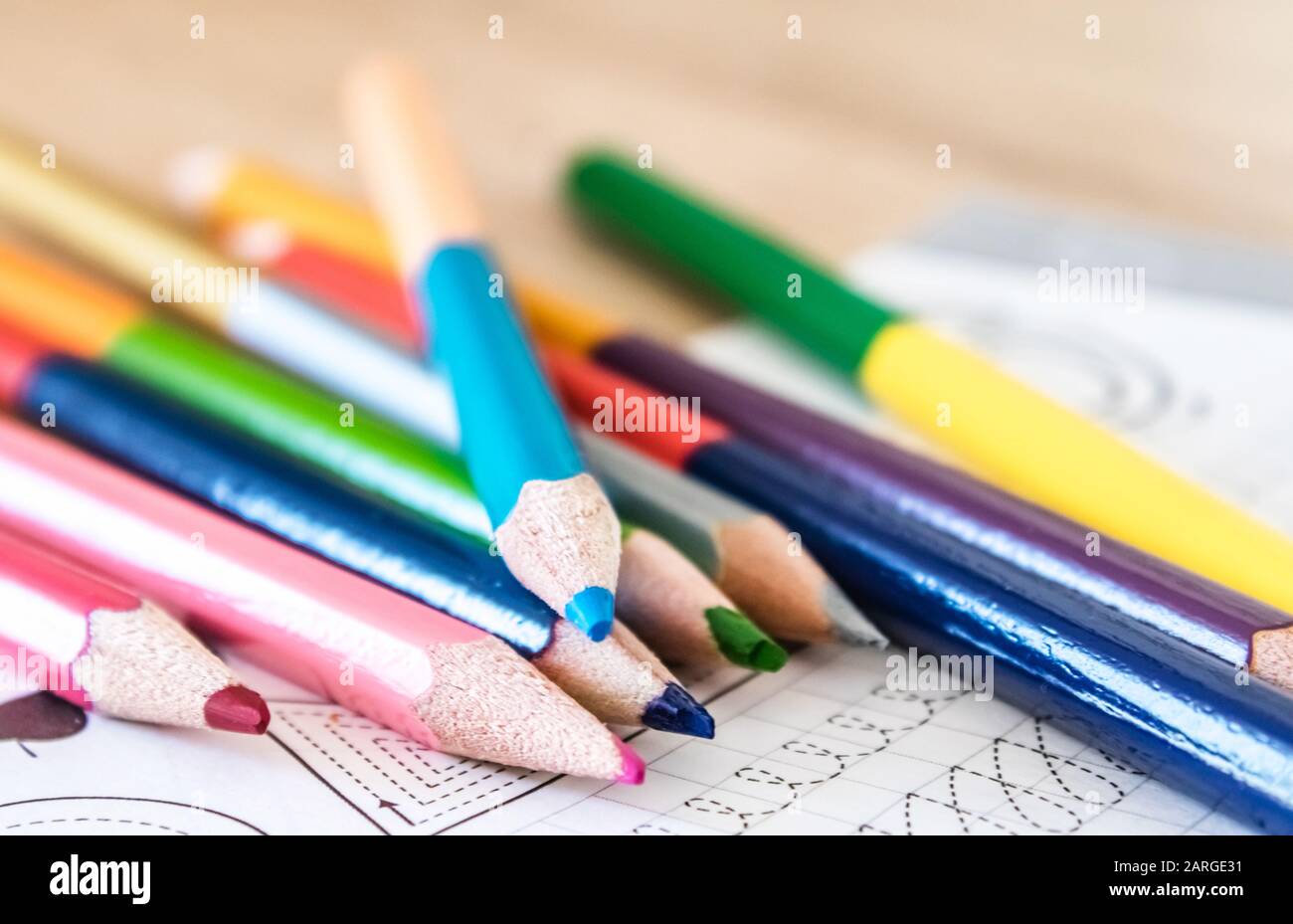Colored pencils scattered on a school notebook. Close-up Stock Photo ...