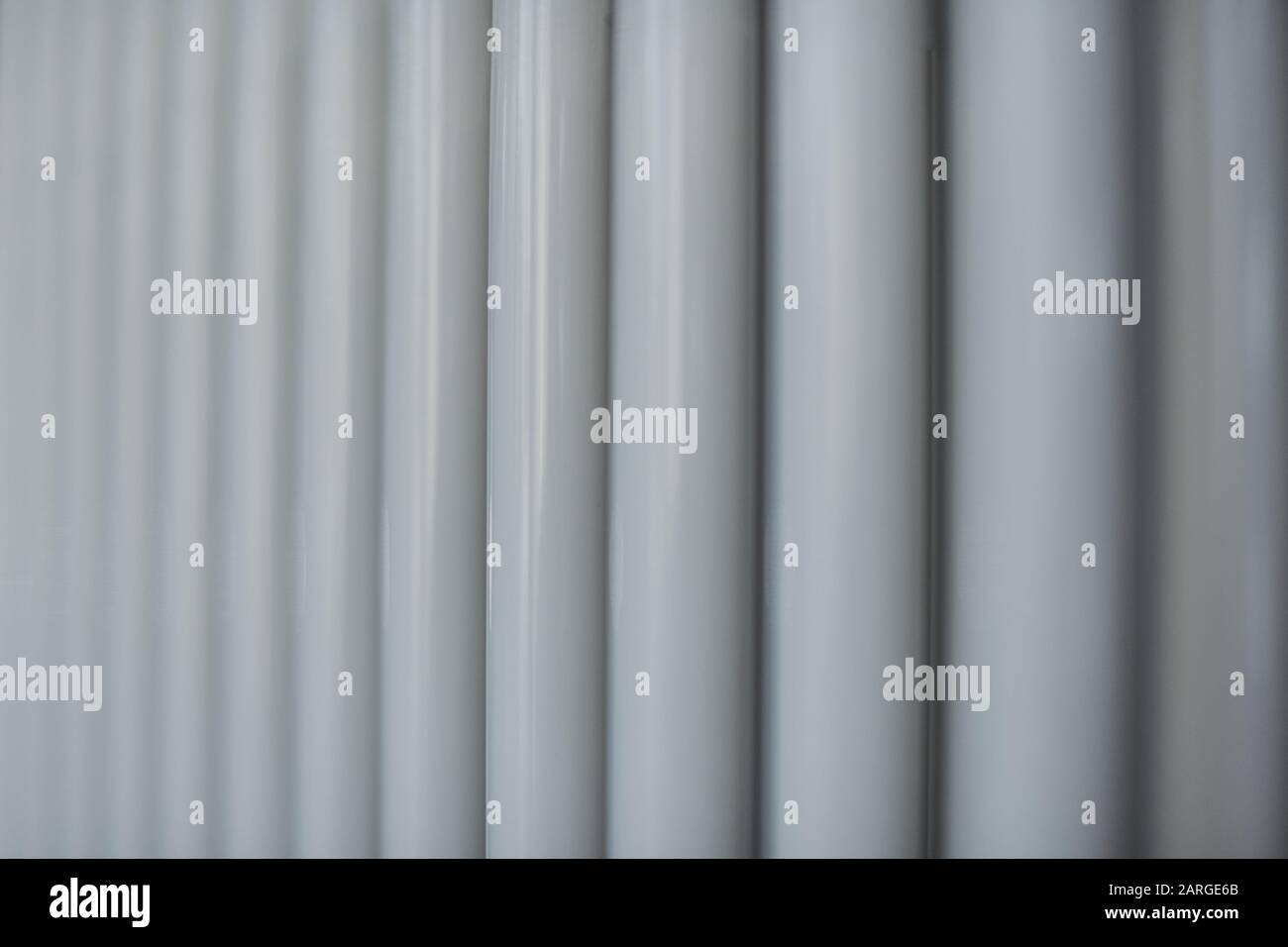 Heating radiator in office, close up. White heat exchangers. Iron ...