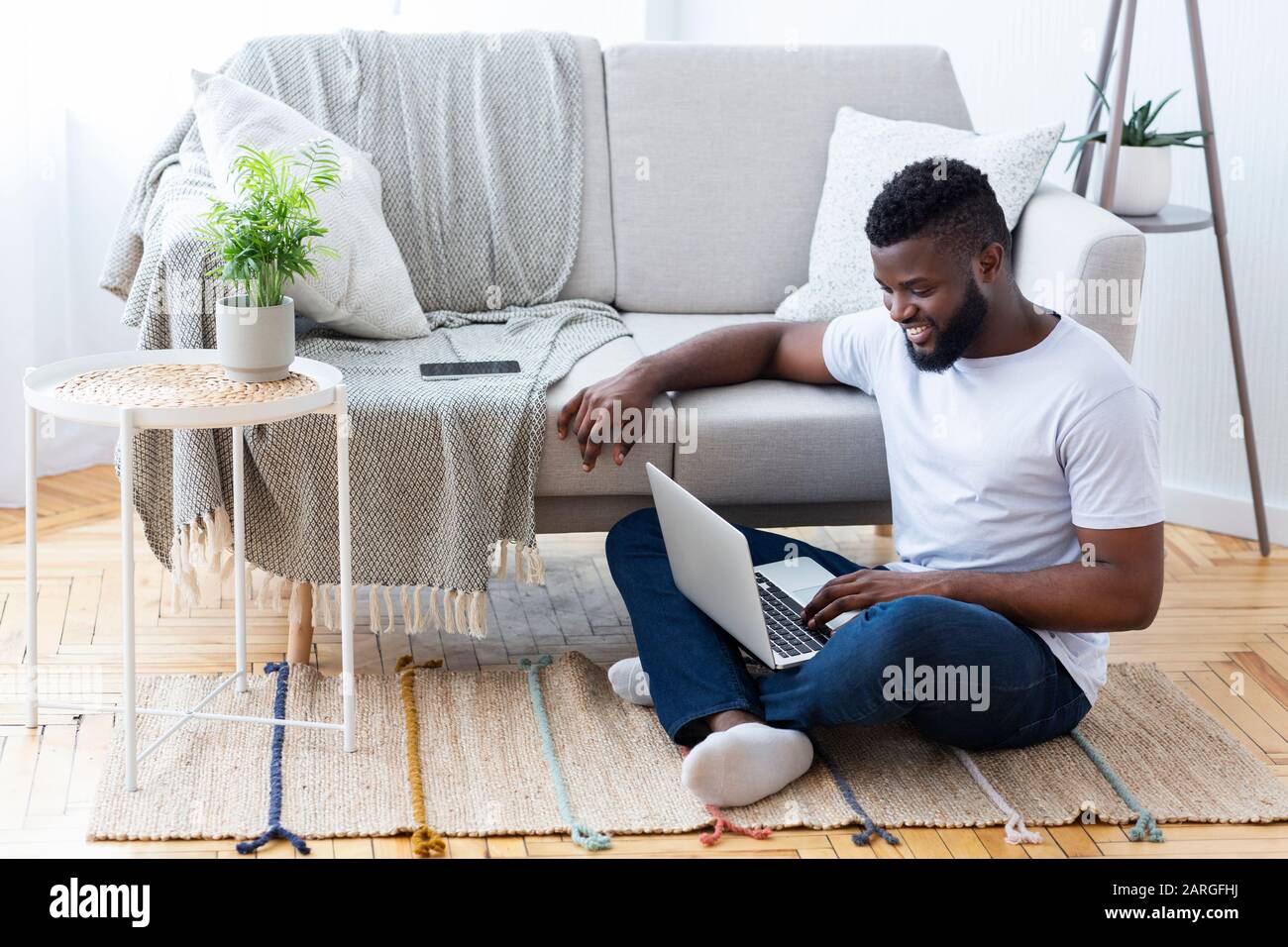Happy positive young man surfing hi-res stock photography and images ...