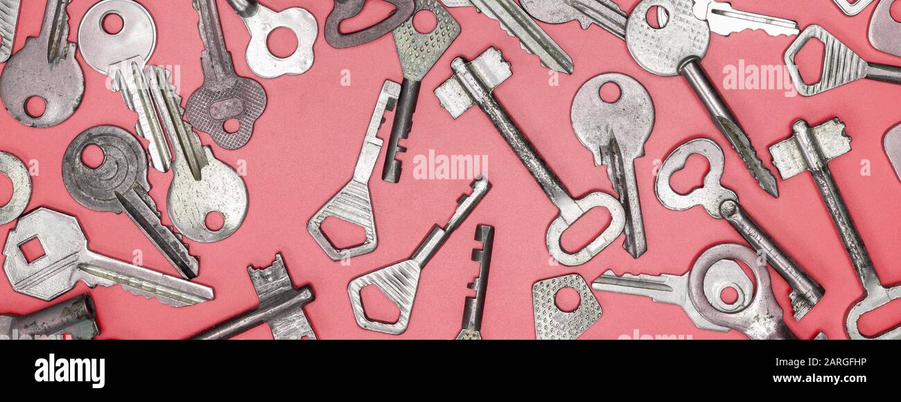 Keys set on pink background. Door lock keys and safes for property ...