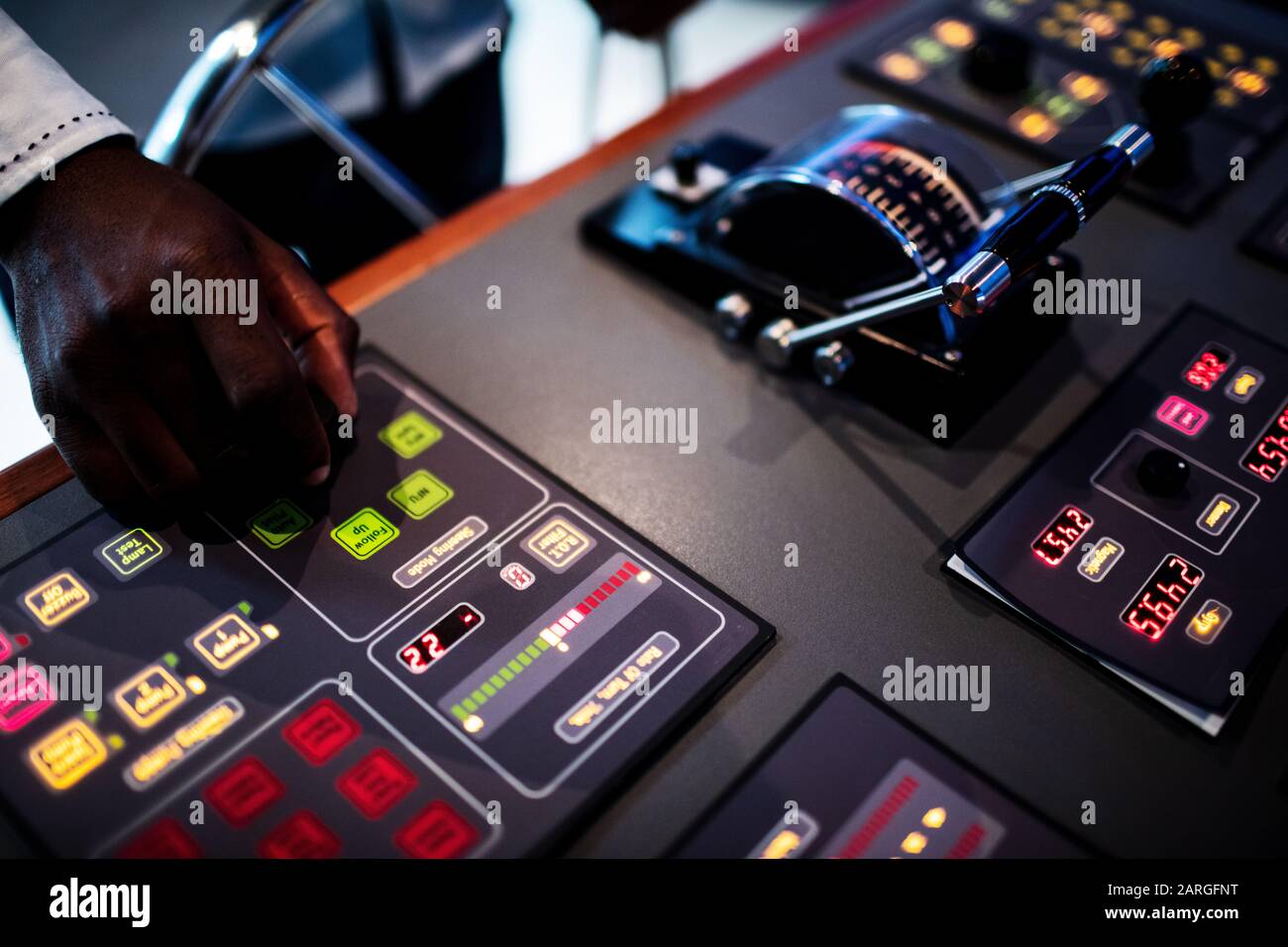 Boat captain hands navigating and moving instruments in the cockpit ...