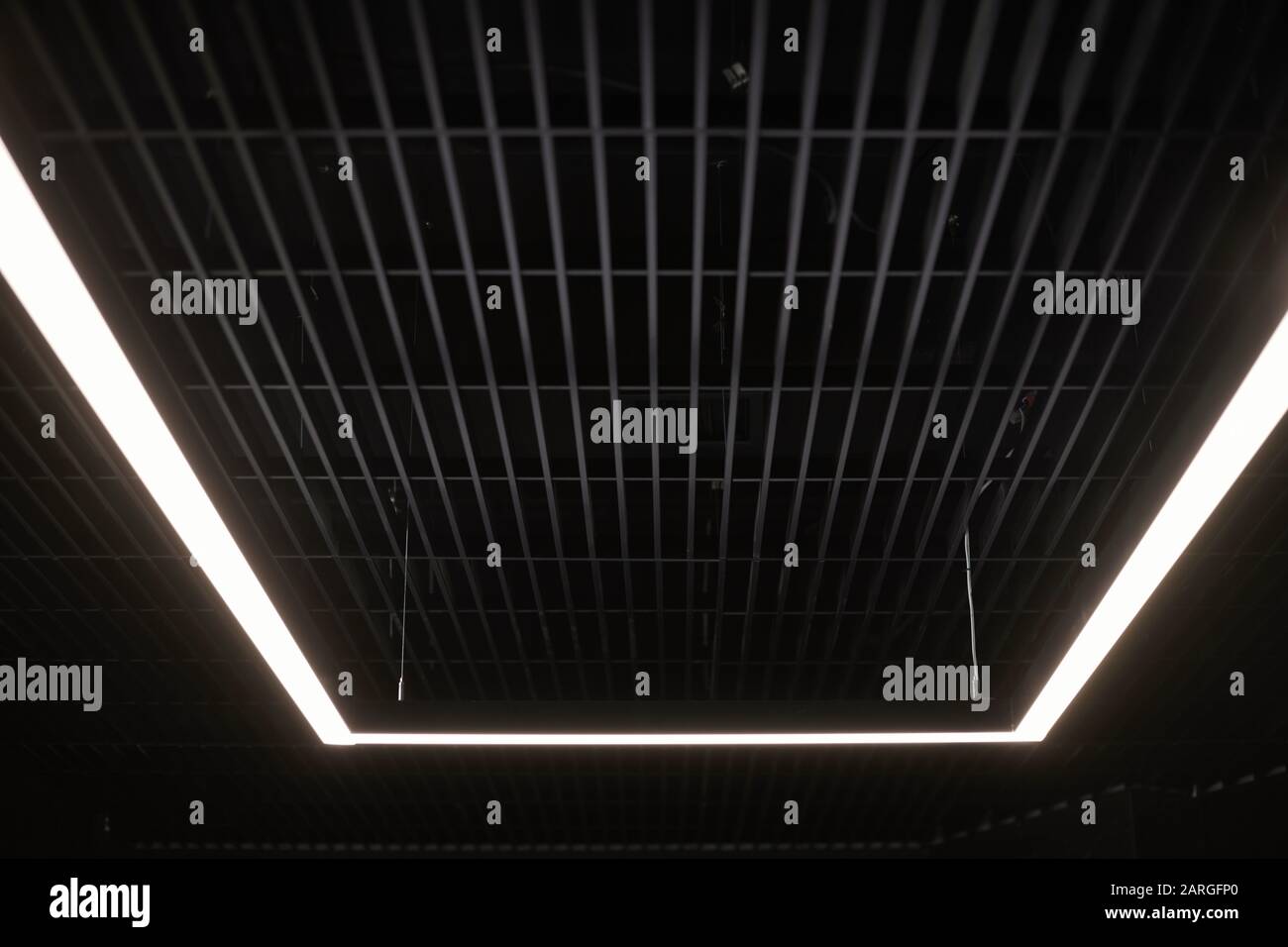 Modern office lighting. Thin lamps in office dark ceiling. LED white ...