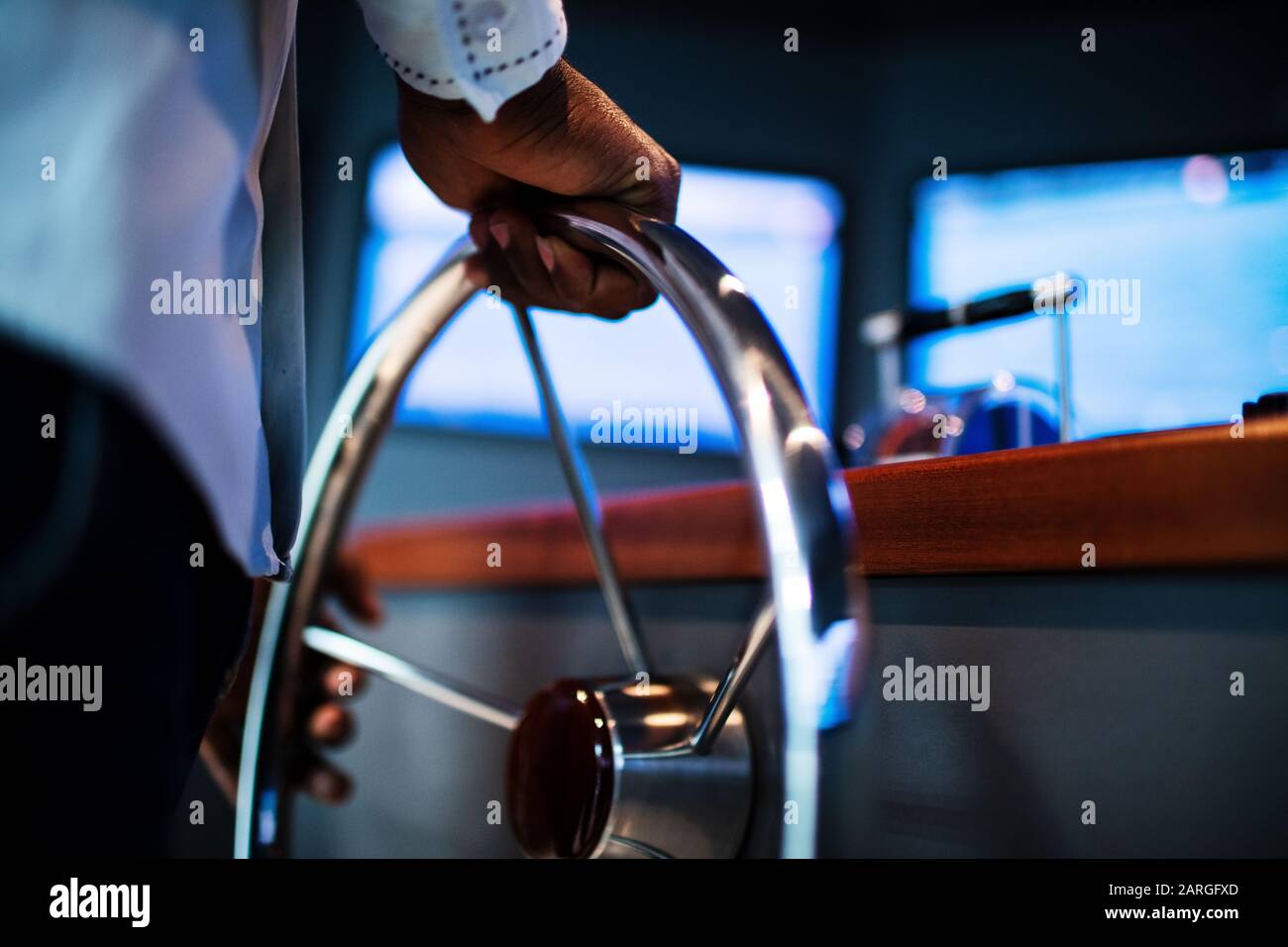 Boat captain hands navigating and moving instruments in the cockpit ...