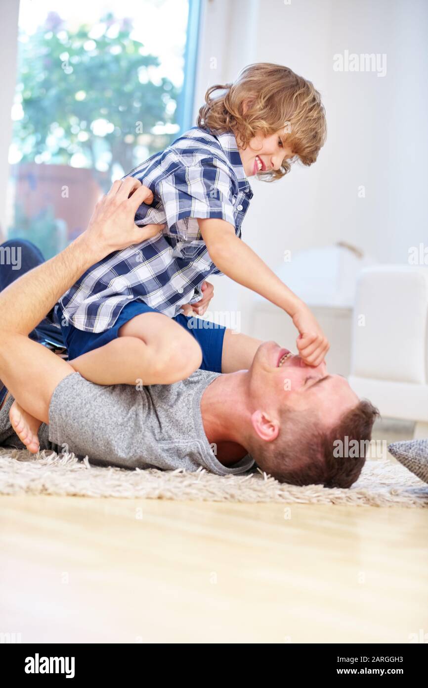 Happy father with his son romping around at home Stock Photo - Alamy