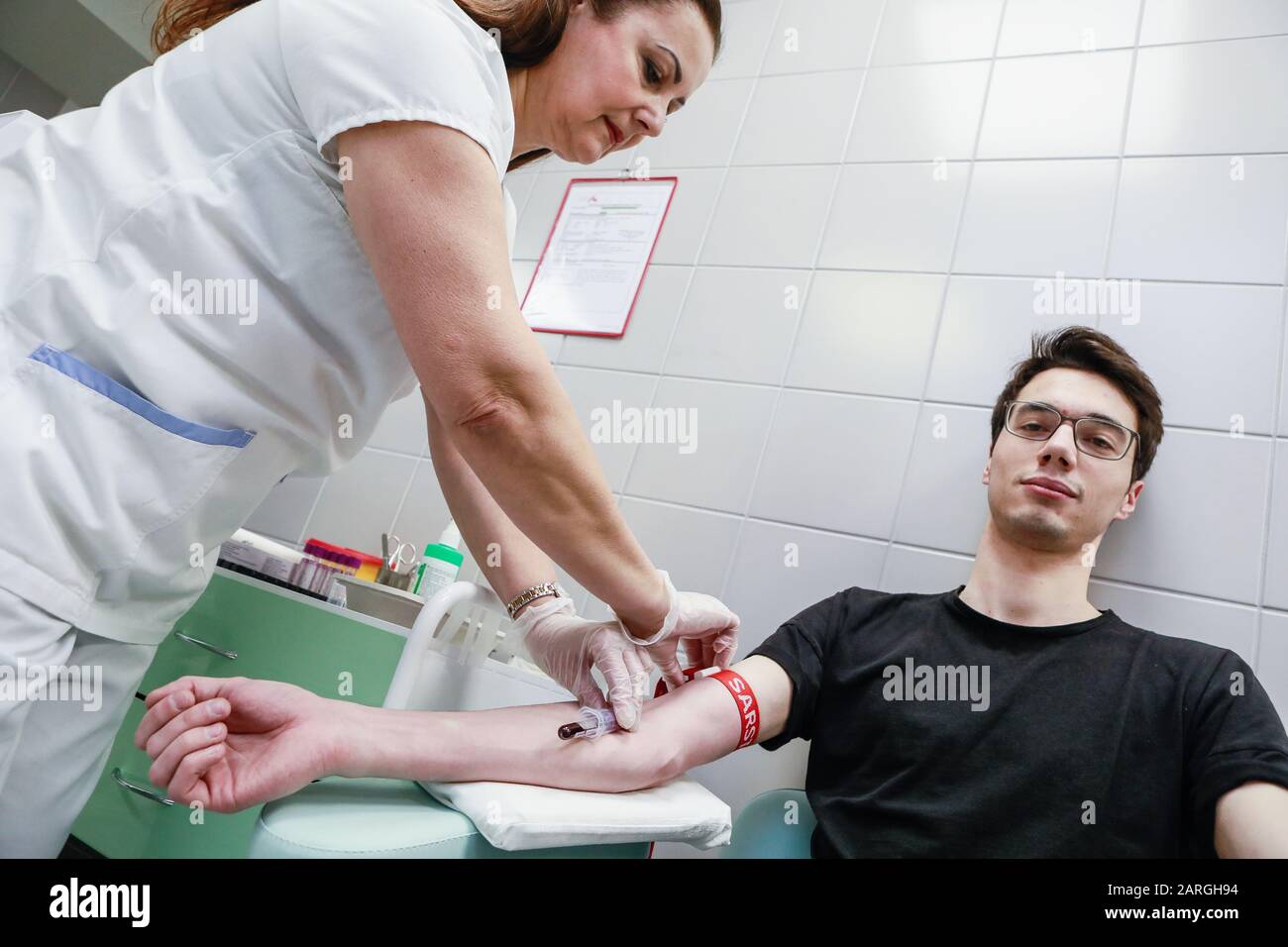 A blood donor sits on the chair to donate blood in the Hospital of St ...