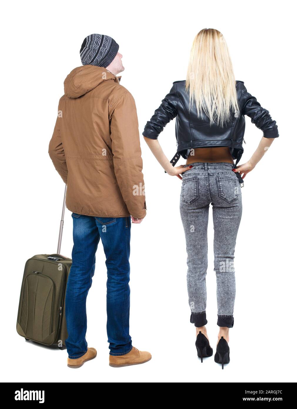 young couple in winter jacket traveling with suitcas. Back view. Rear ...