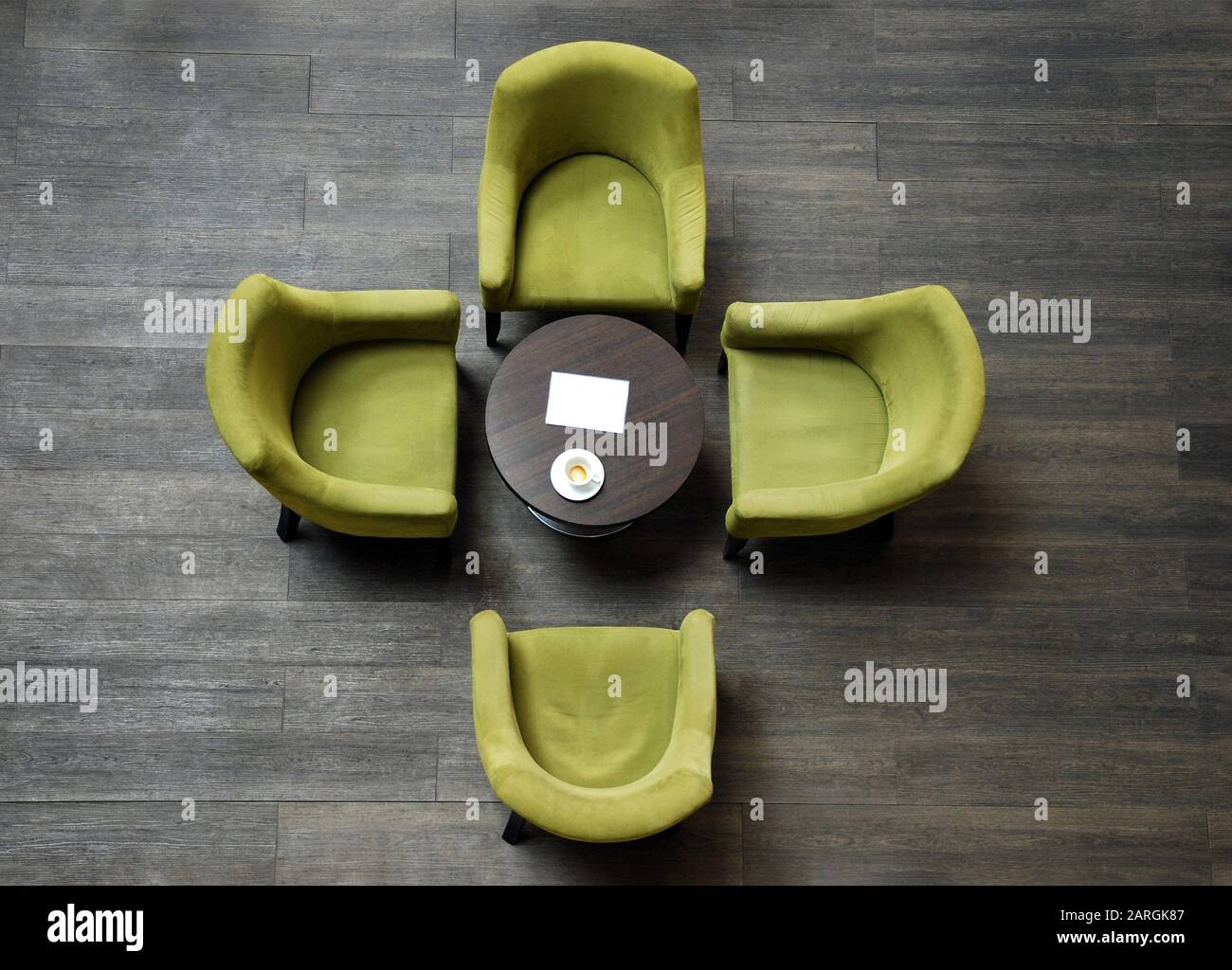 Four empty chairs, round table with empty cup of coffee. Visitor has ...