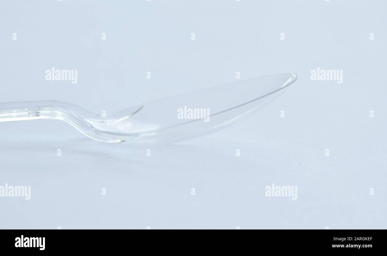 clear and translucent plastic spoon on white background Stock Photo - Alamy