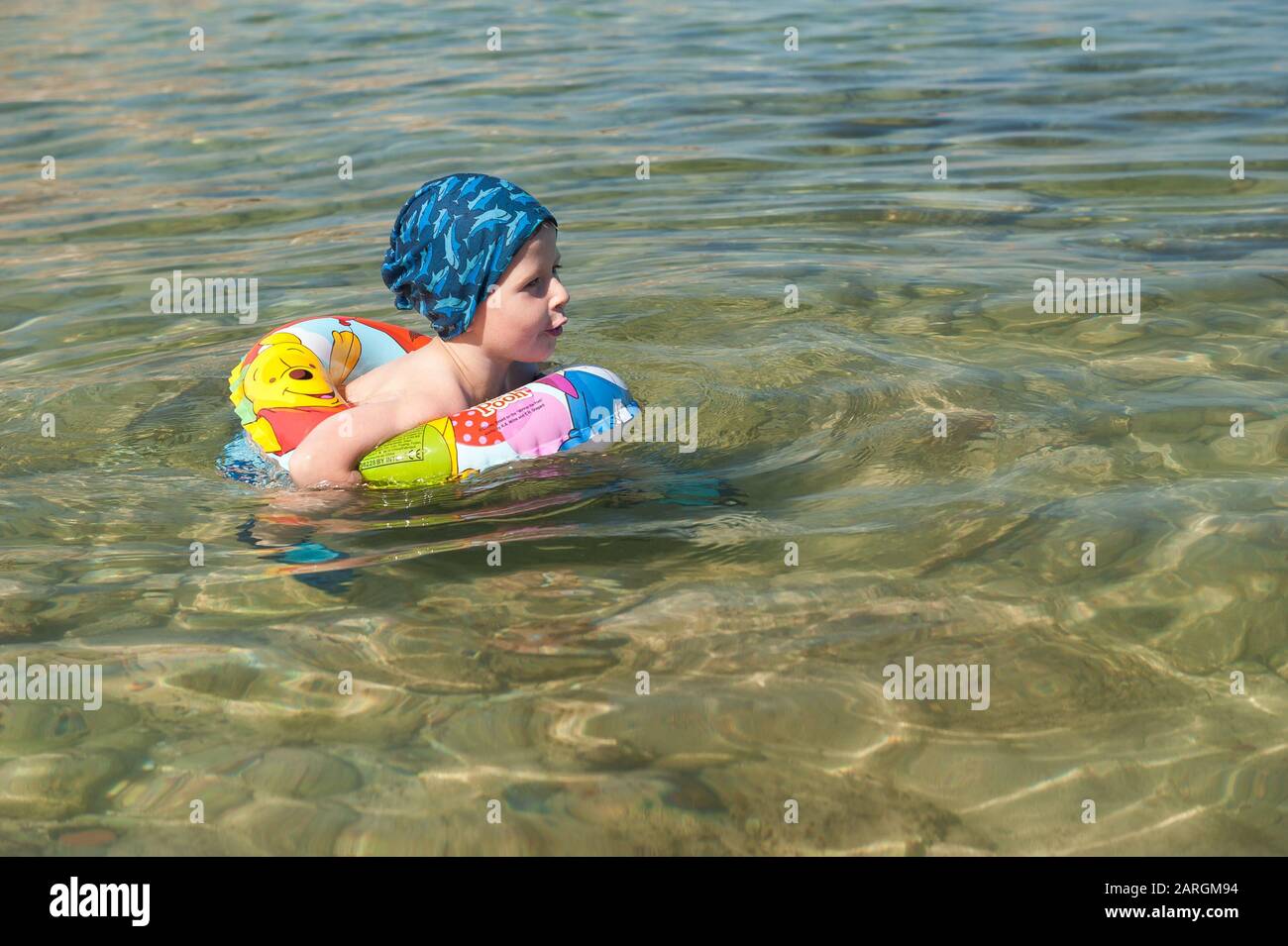 Three year old boy swimming in the sea, Agatha beach, Rhodes, Greece ...