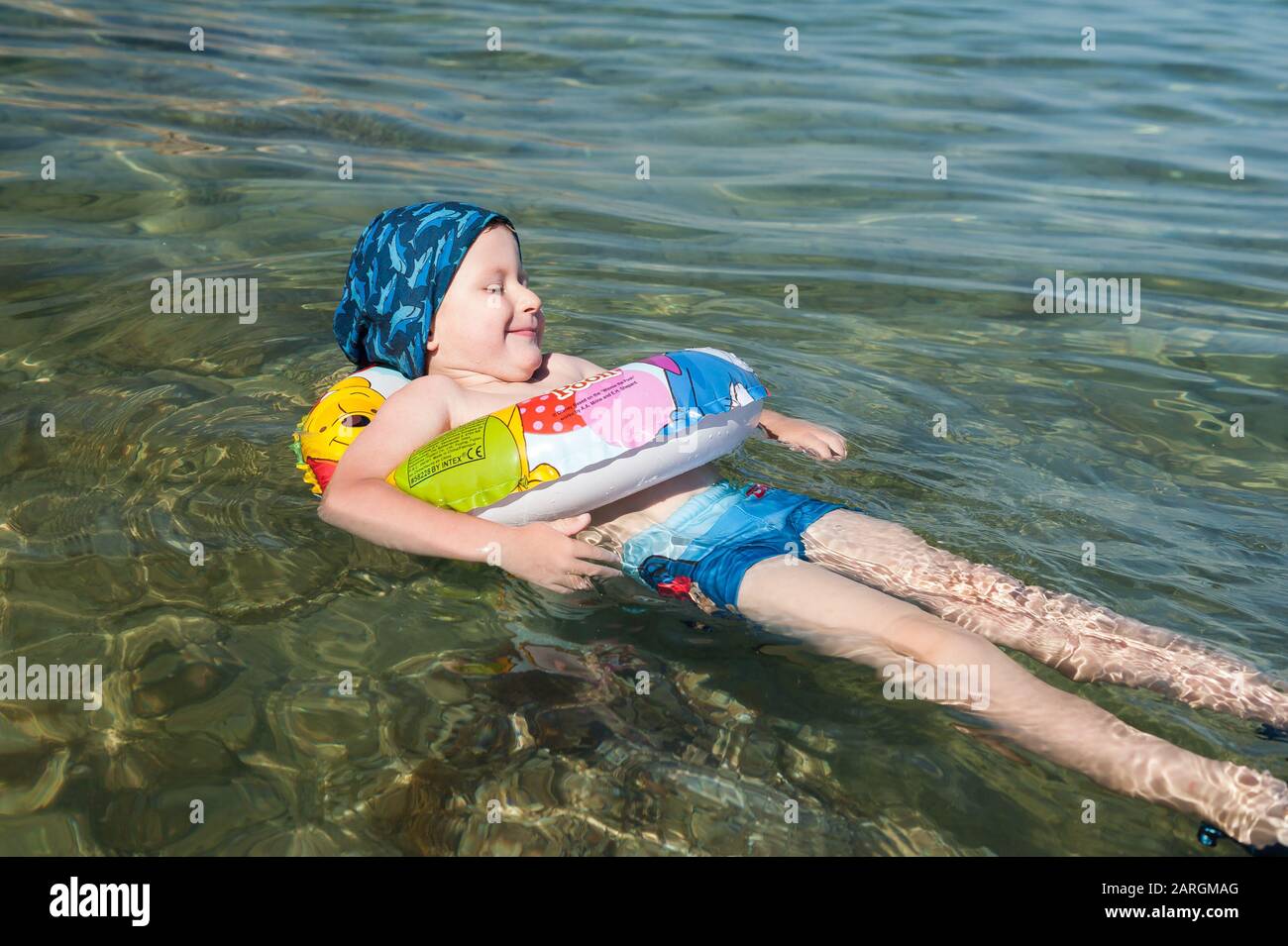 Three year old boy swimming in the sea, Agatha beach, Rhodes, Greece ...