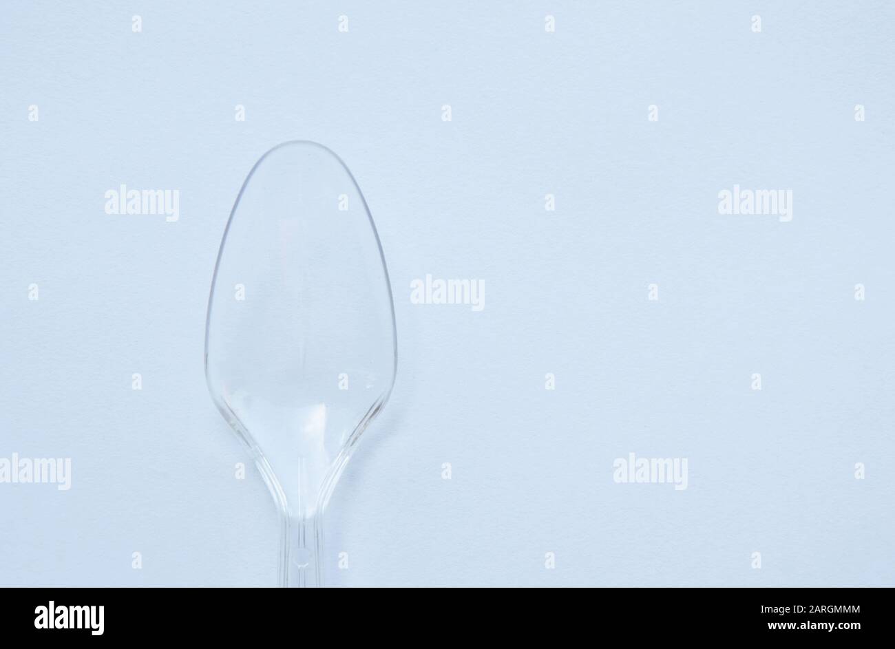 clear and translucent plastic spoon on white background Stock Photo - Alamy