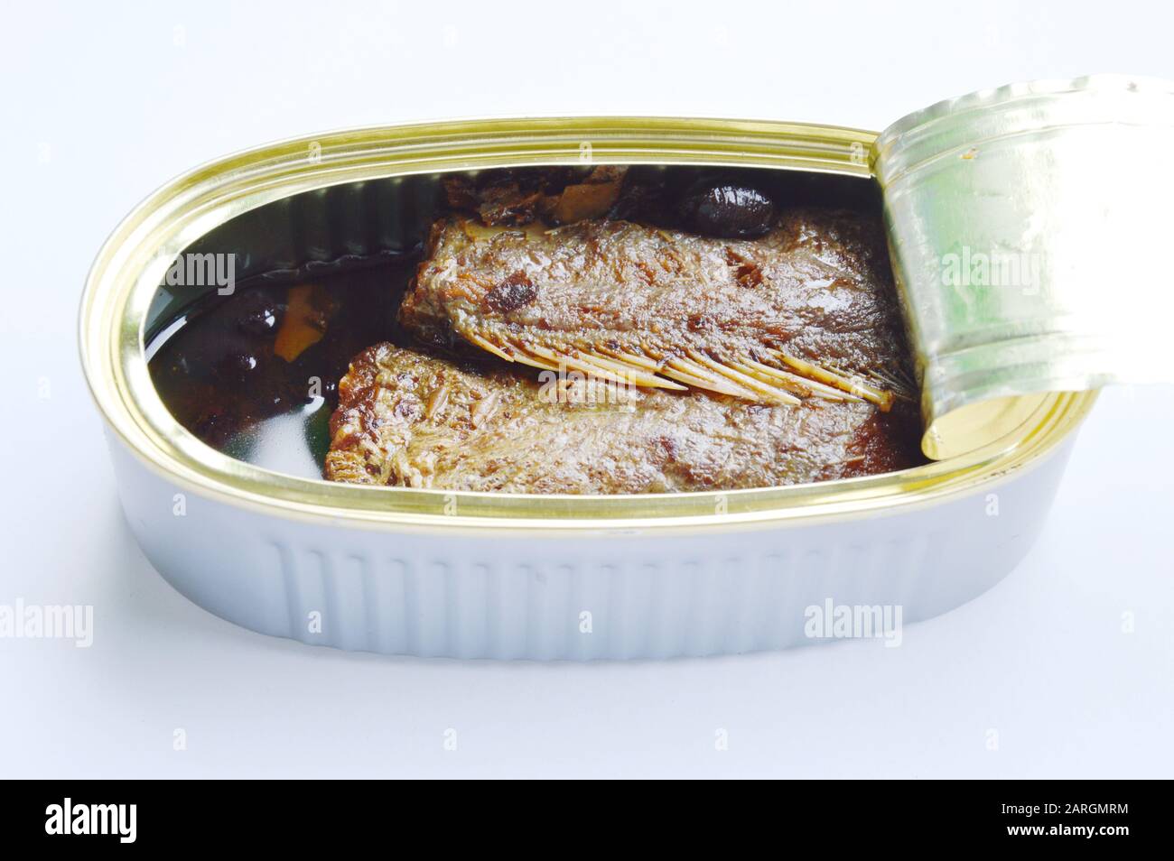 salty fried fish in tin canned opened on white background Stock Photo ...