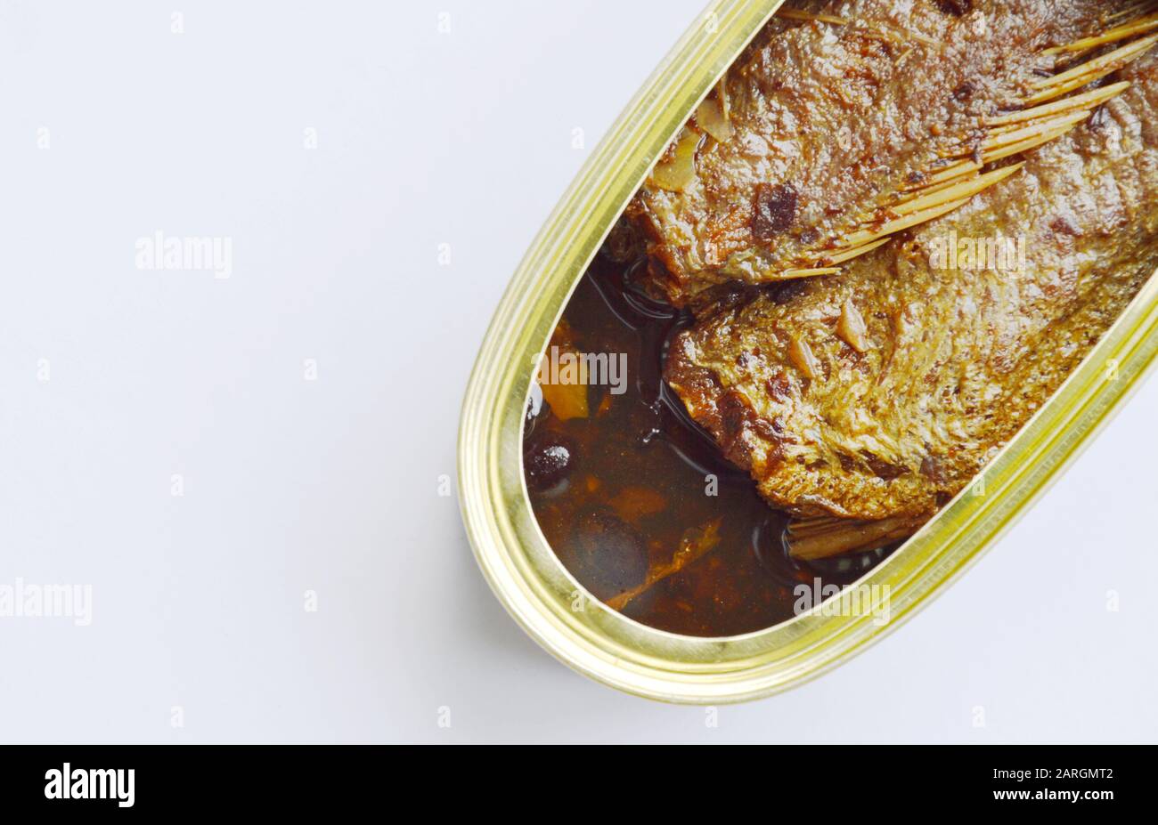 salty fried fish in tin canned opened on white background Stock Photo ...