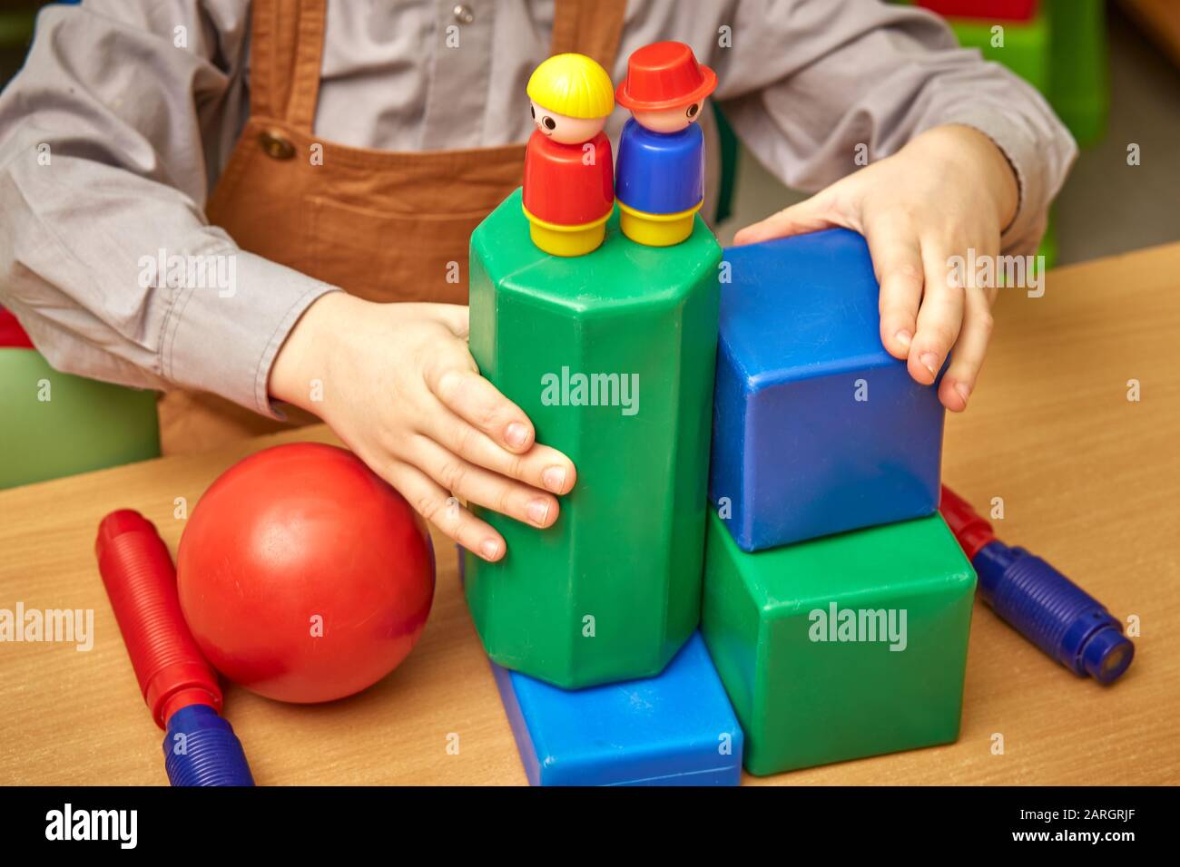 Child's hands playing with colorful toy blocks Stock Photo - Alamy