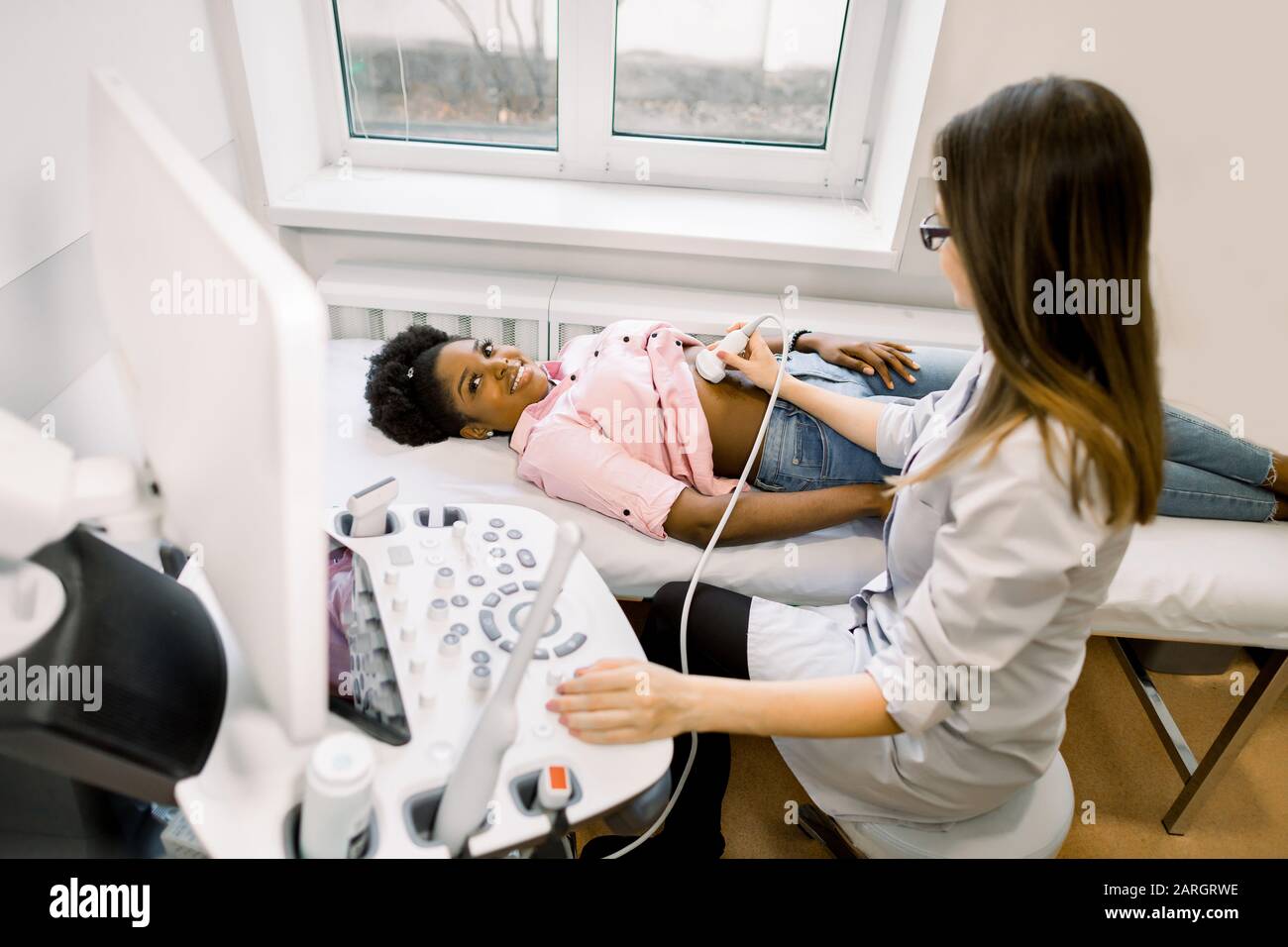 Ultrasound diagnostic of stomach on abdominal to young African woman ...