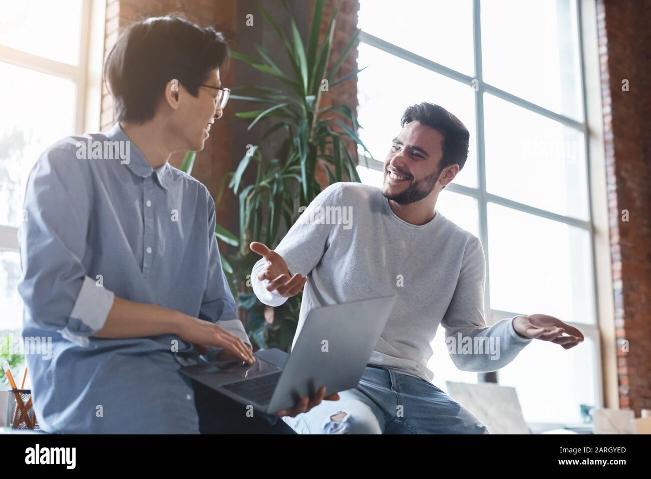 Two coworkers having conversation during break time in office Stock ...