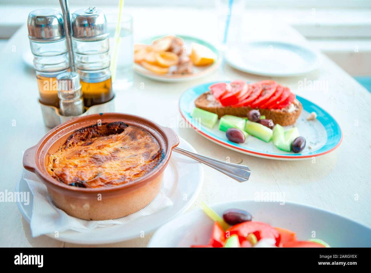 Outdoor cafe on a street of typical greek traditional village in Greece ...